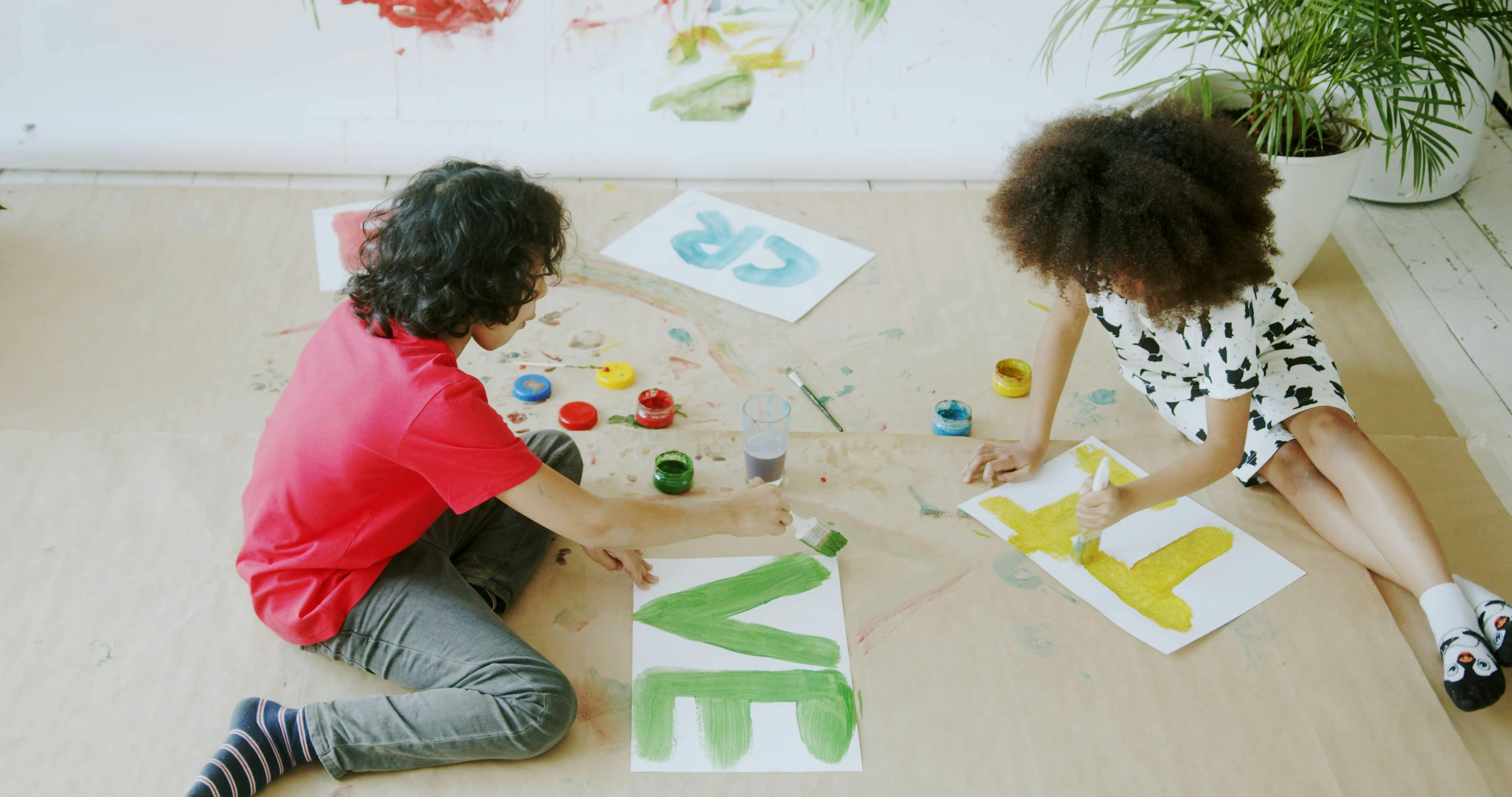 A Kid Drawing on Big Canvas · Free Stock Video