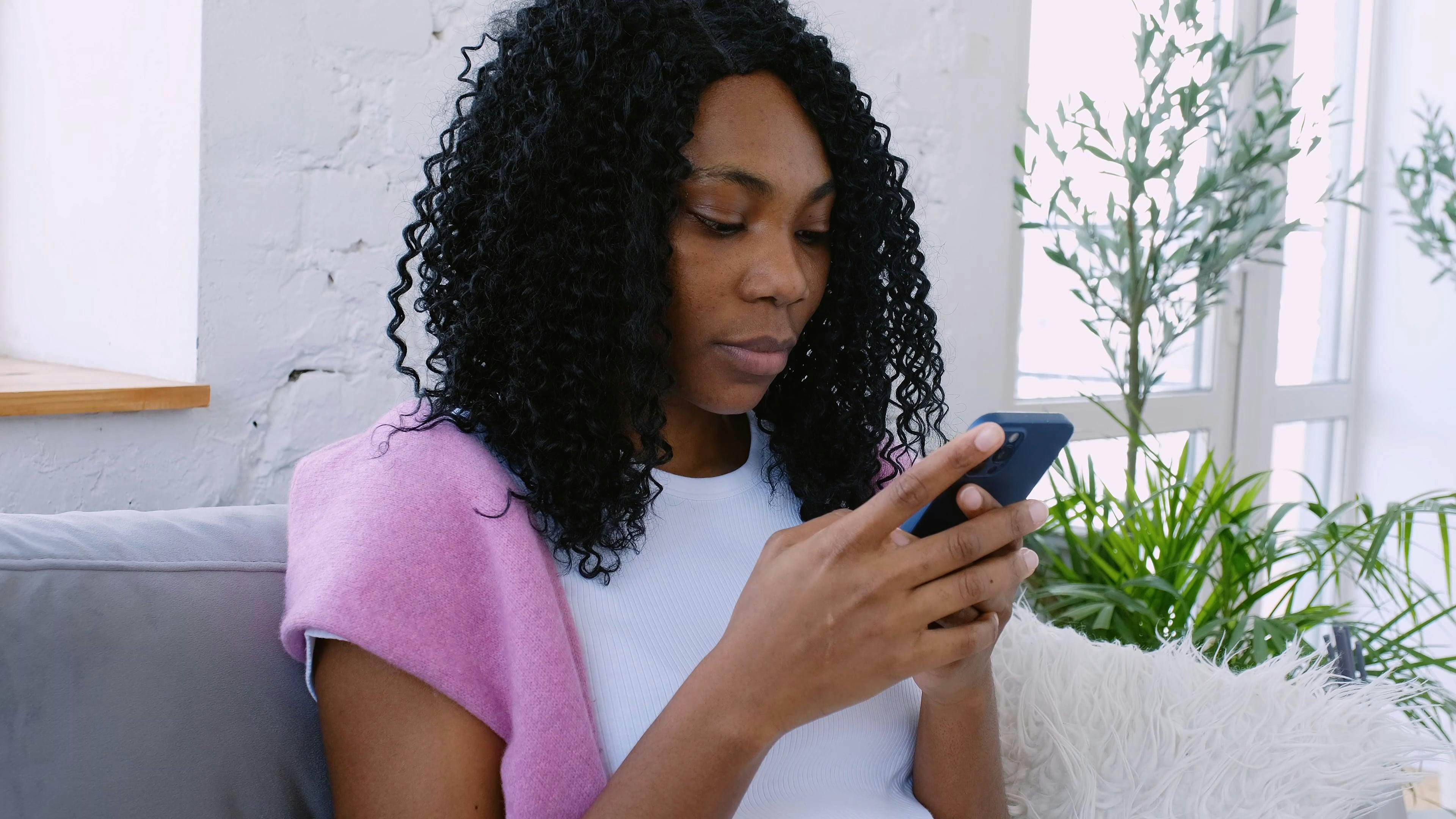 A Woman Smiling While Texting · Free Stock Video