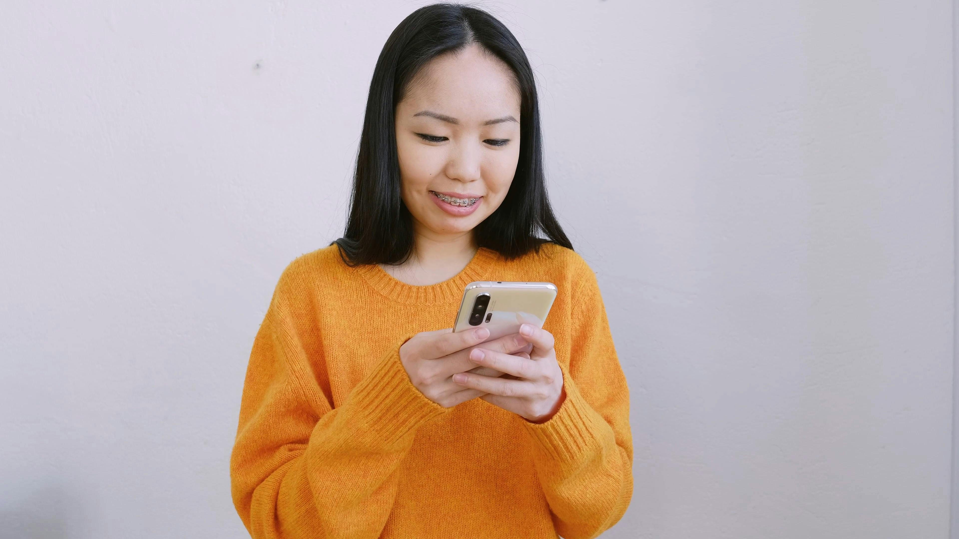 A Woman Smiling While Texting Free Stock Video Footage, Royalty-Free 4K ...