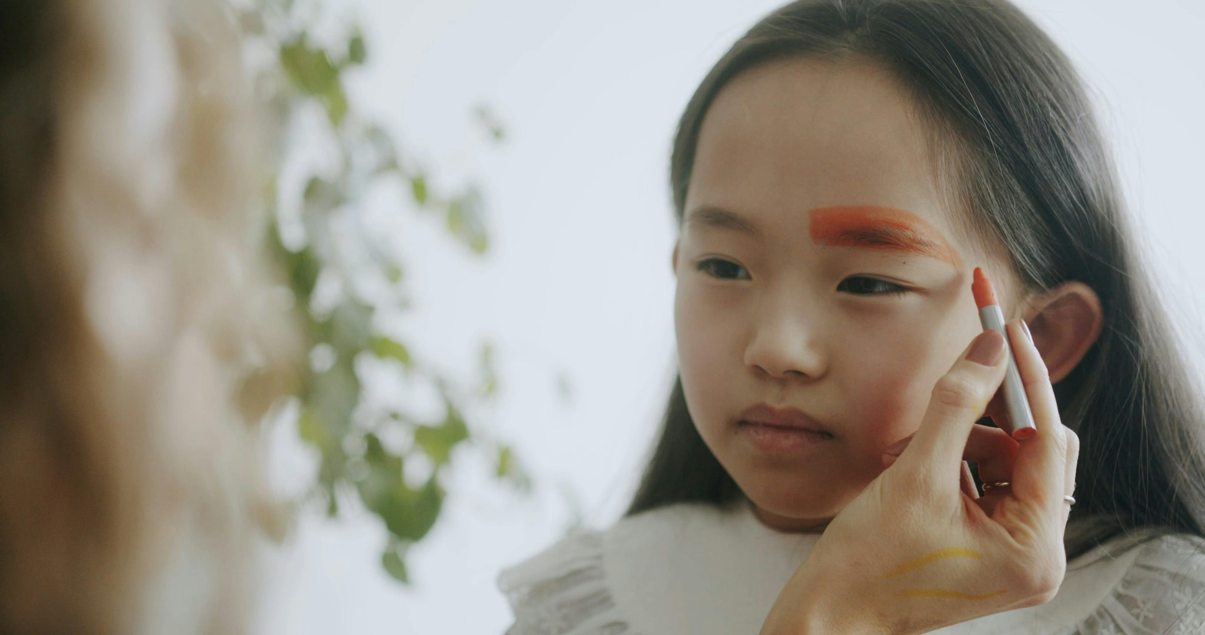 A Person Applying Face Paint on a Girl Free Stock Video Footage ...