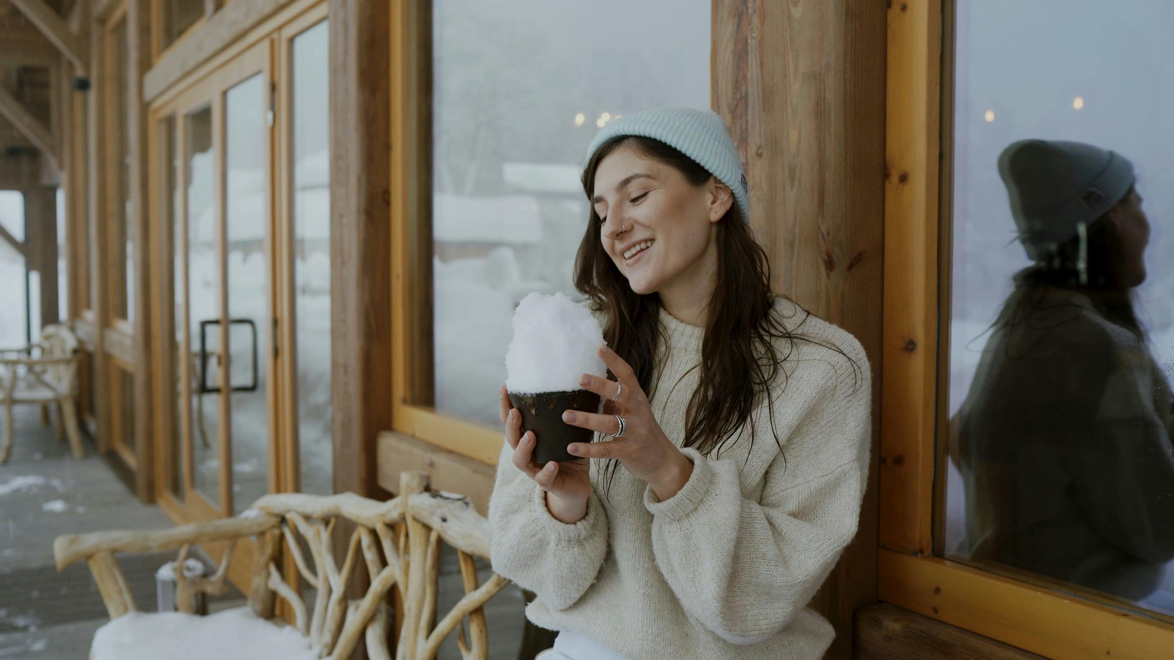 Woman Licking and Eating Snow in a Cup · Free Stock Video