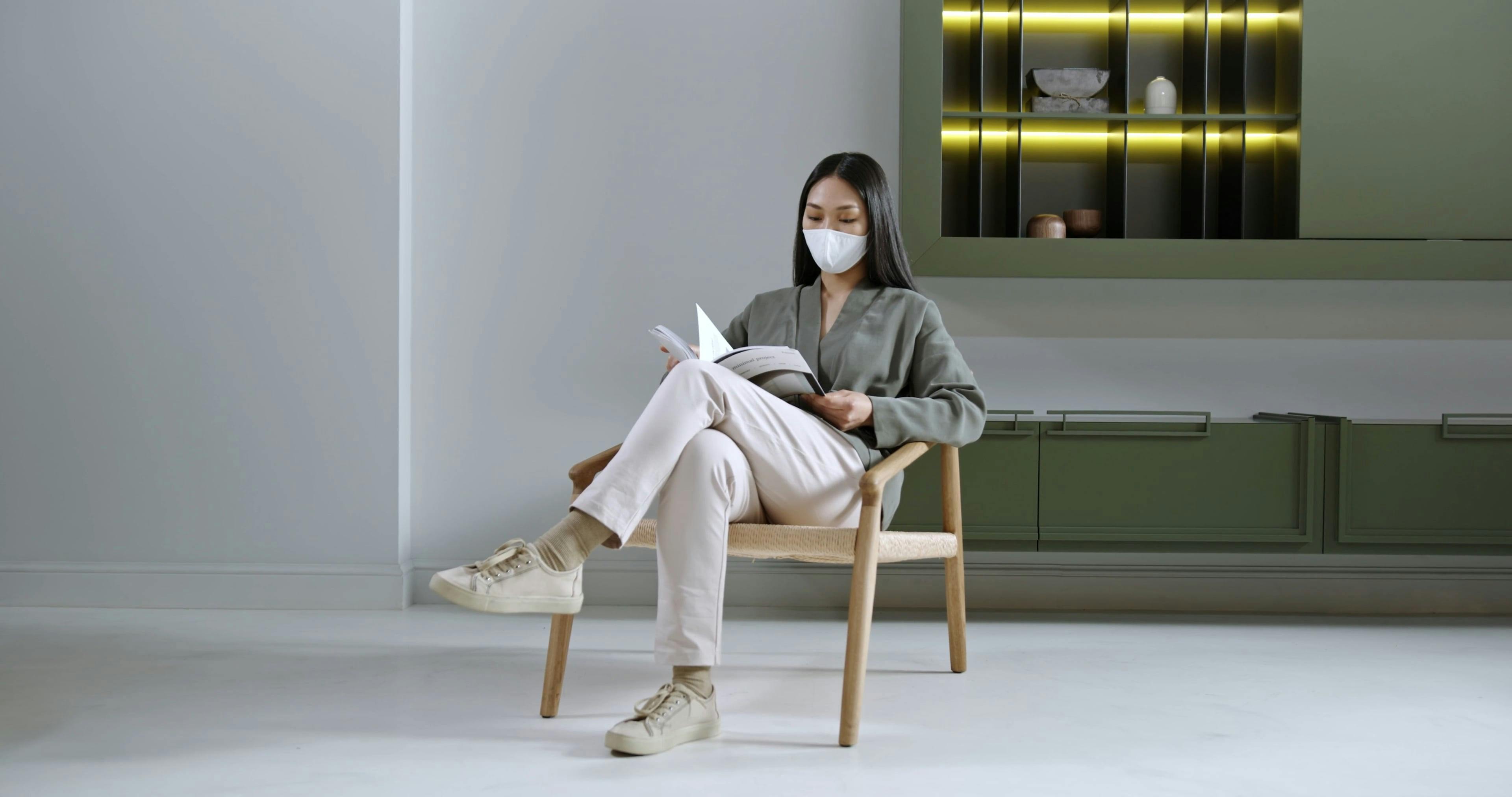 Woman Sitting on Chair Reading a Magazine · Free Stock Video