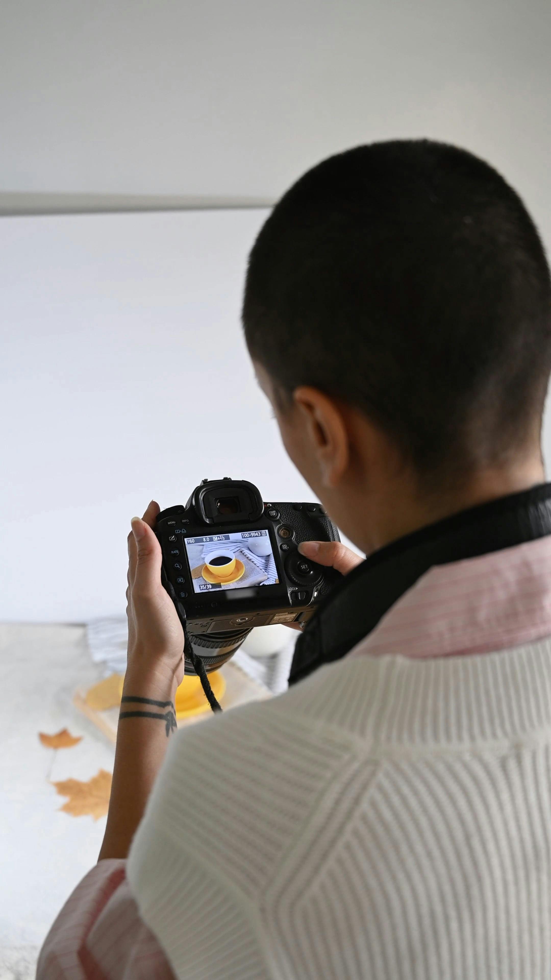 Woman Looking At Pictures Taken From Her Camera · Free Stock Video