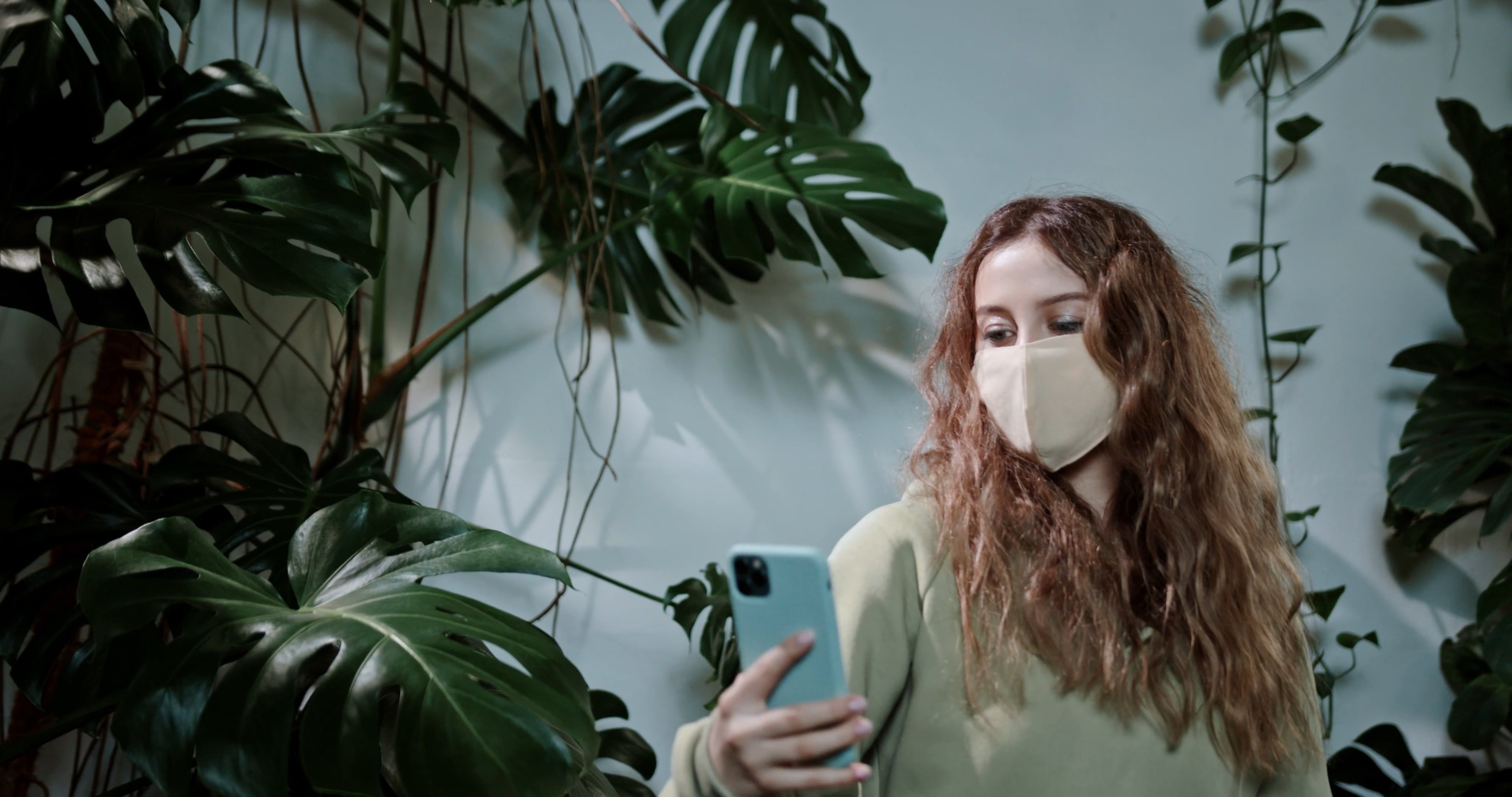 Woman with Face Mask Taking a Selfie · Free Stock Video