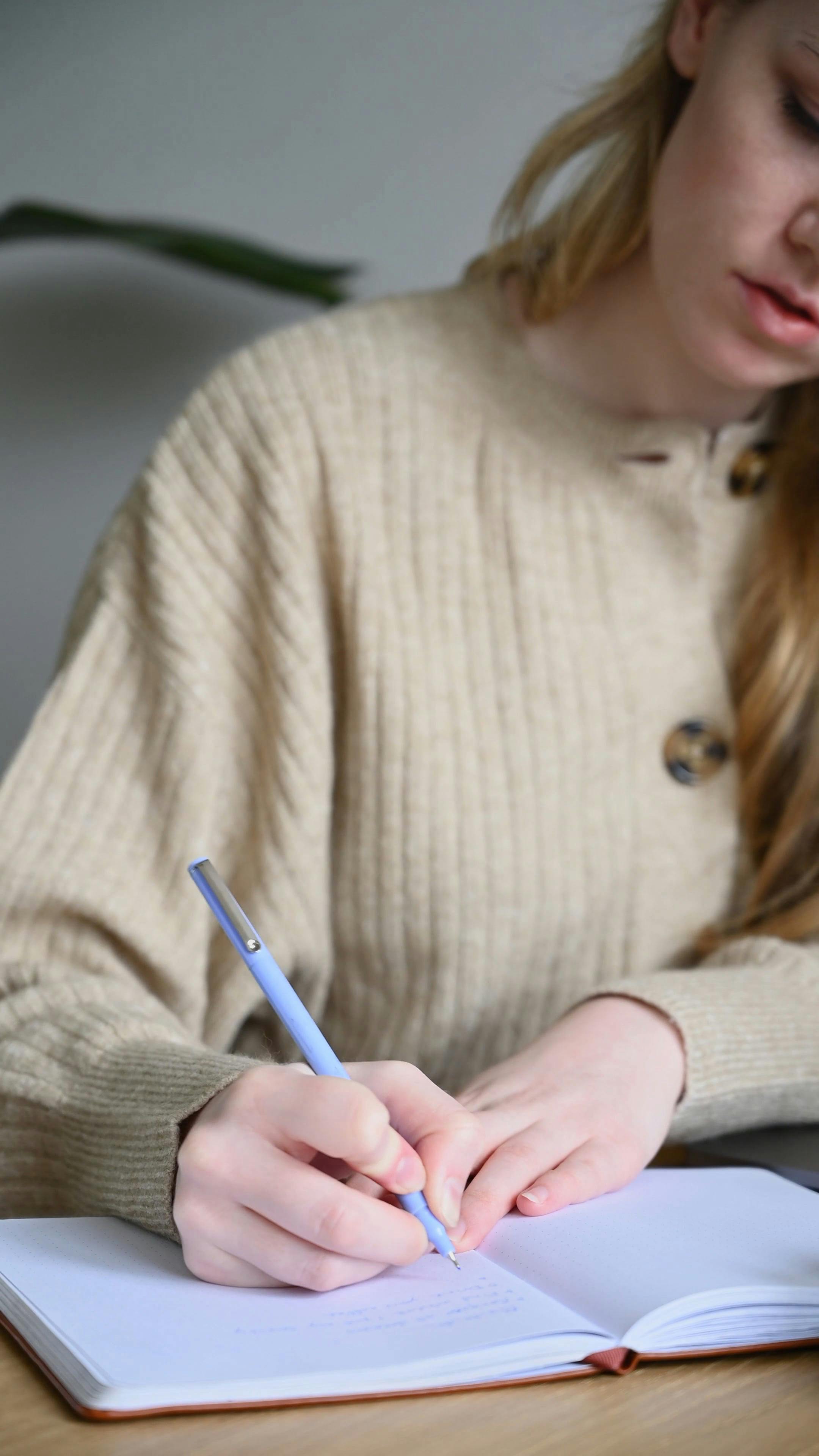 Woman Writing On a Notebook · Free Stock Video