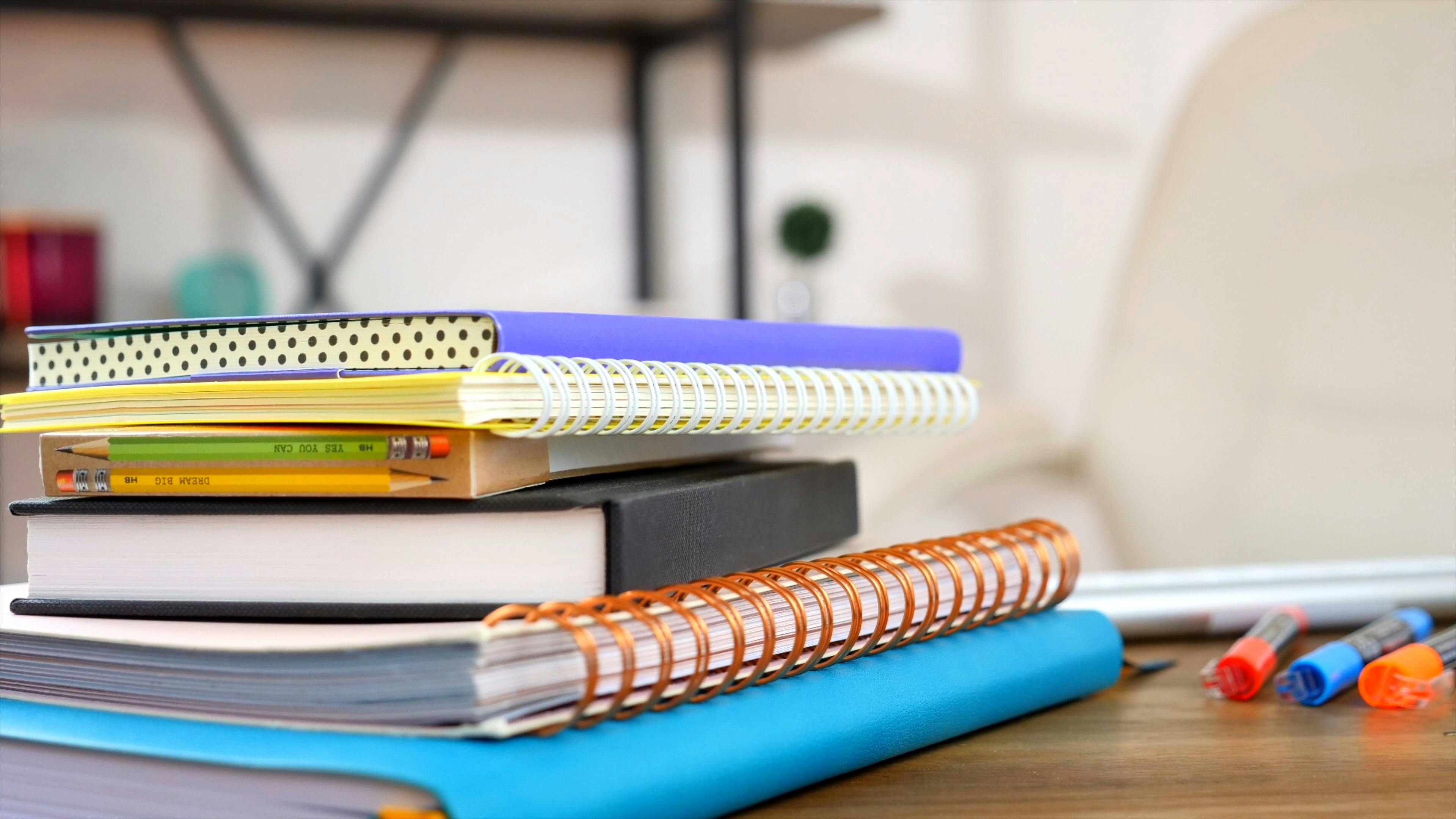 Stack of Notebooks on the Desk · Free Stock Video