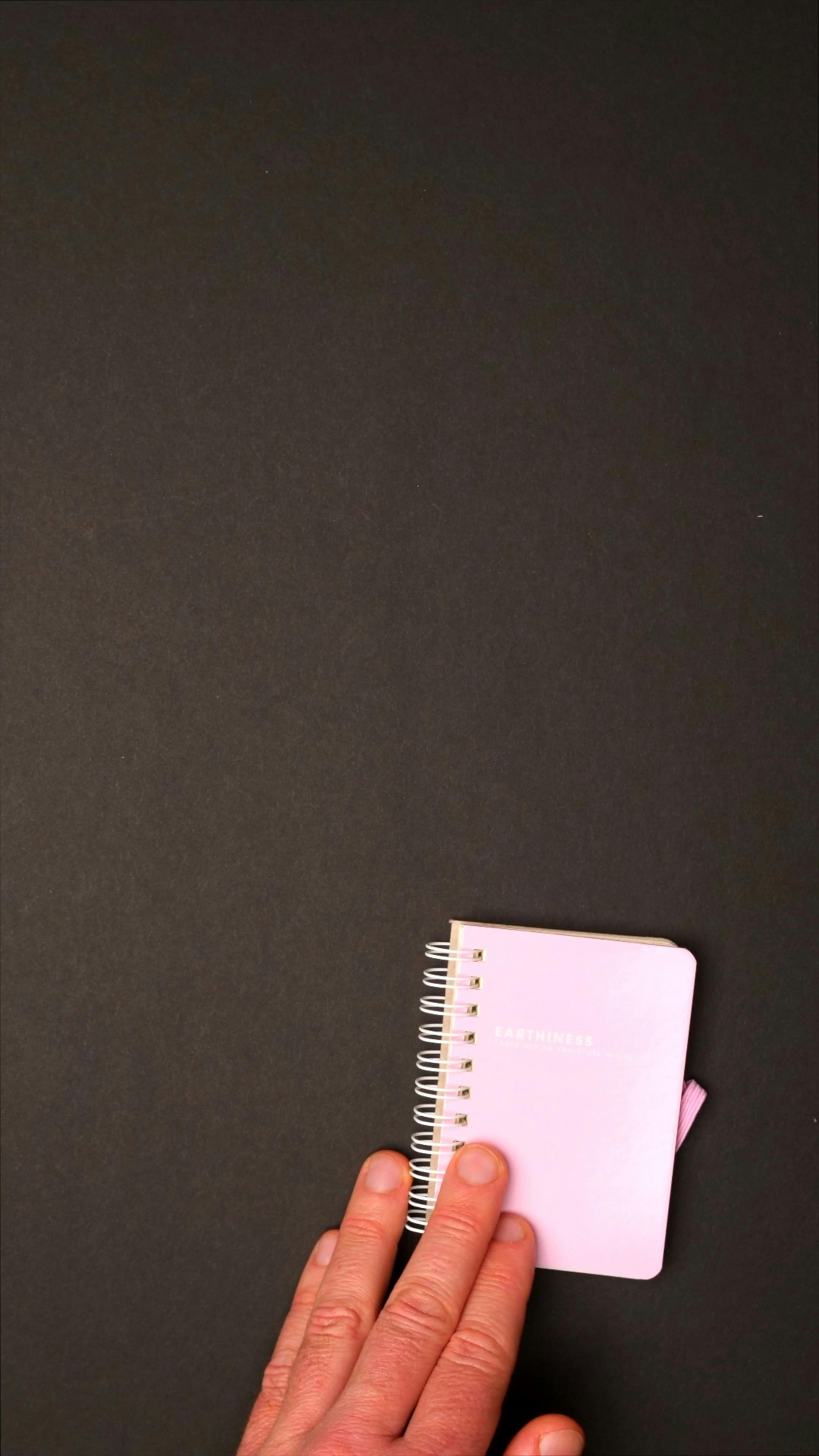 Paper Clips Of Different Colors Moving On Top Of A Black Surface Free ...