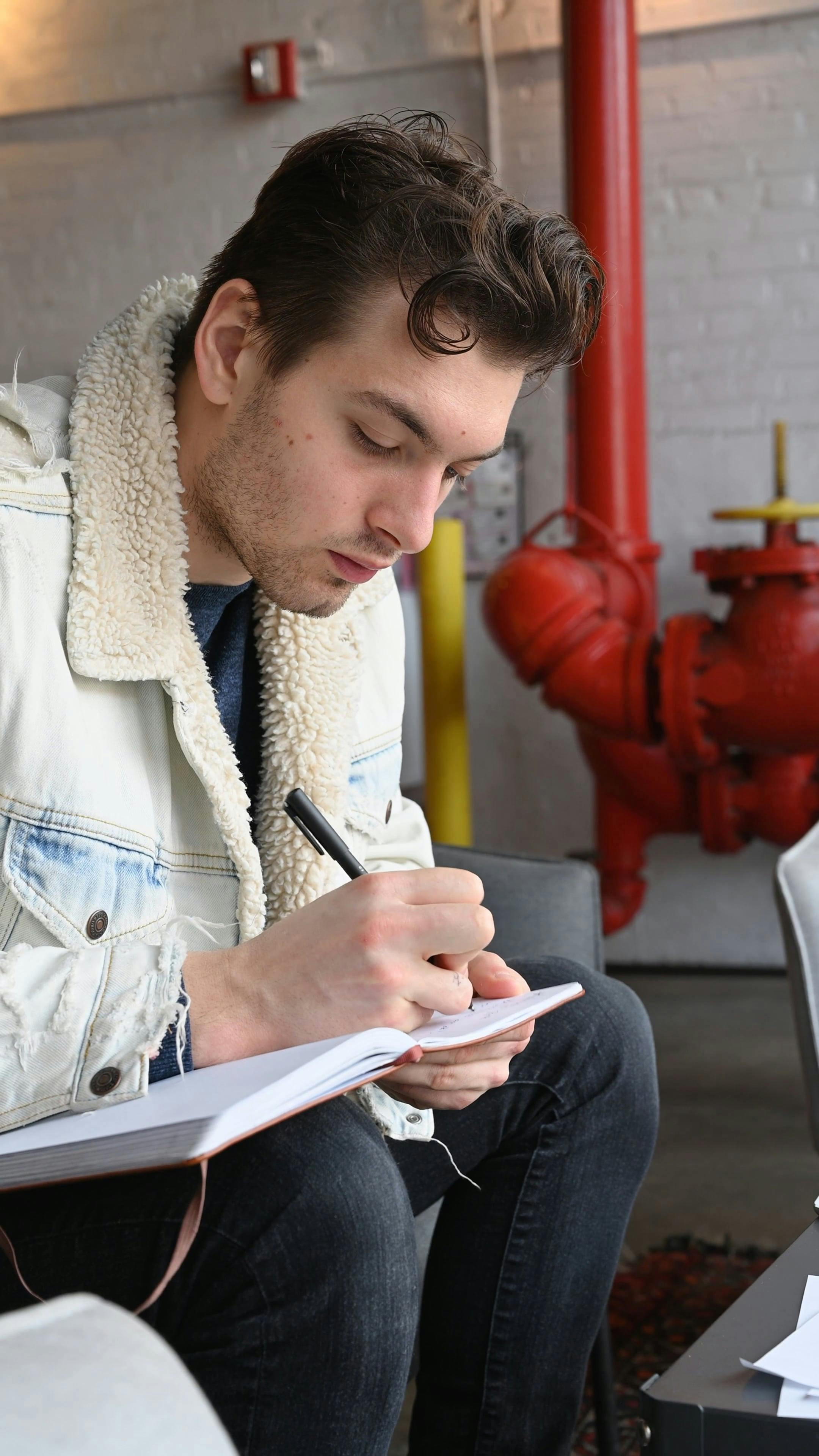 Man Writing On a Notebook · Free Stock Video