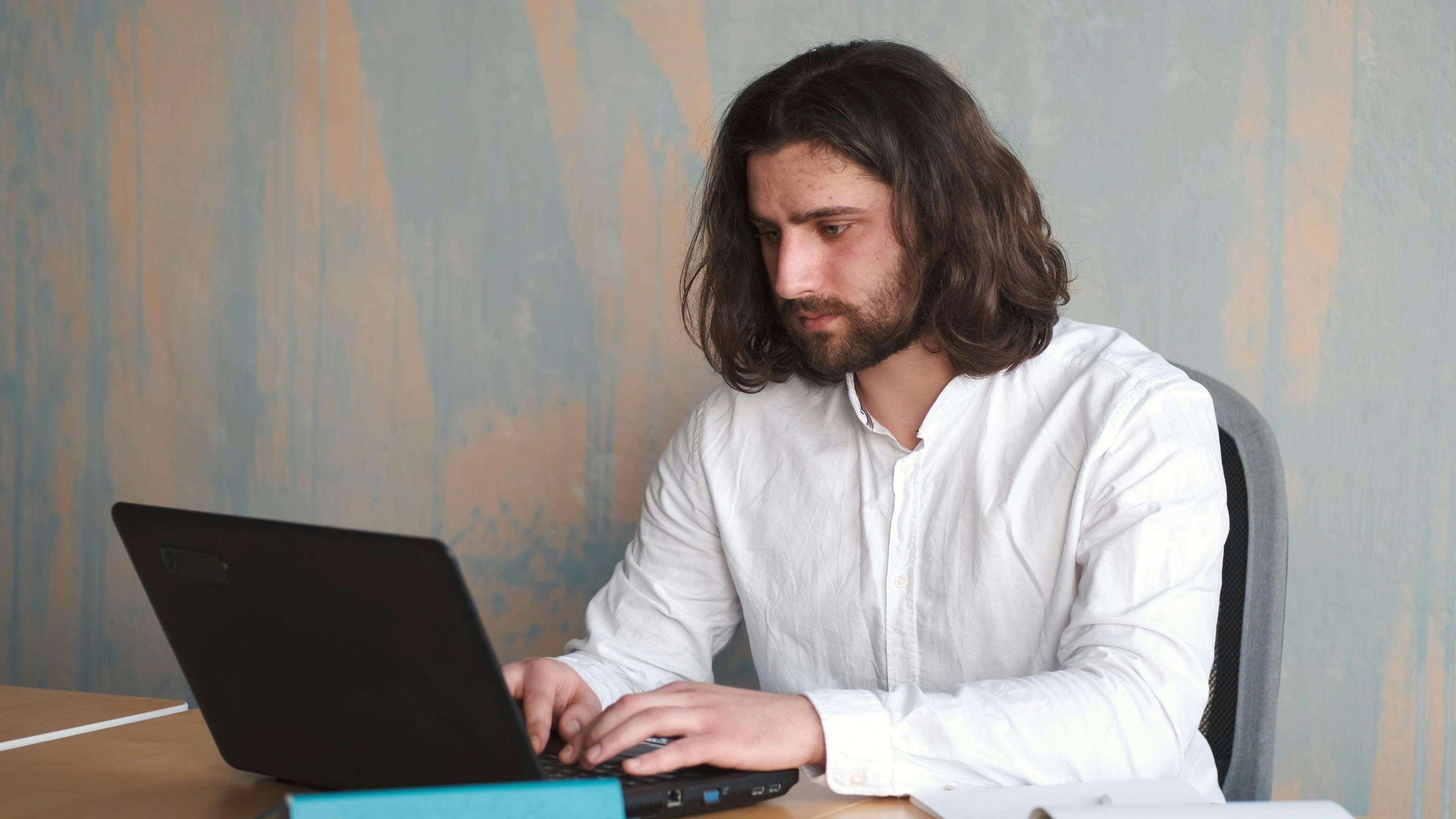 A Man using a Laptop while Working · Free Stock Video