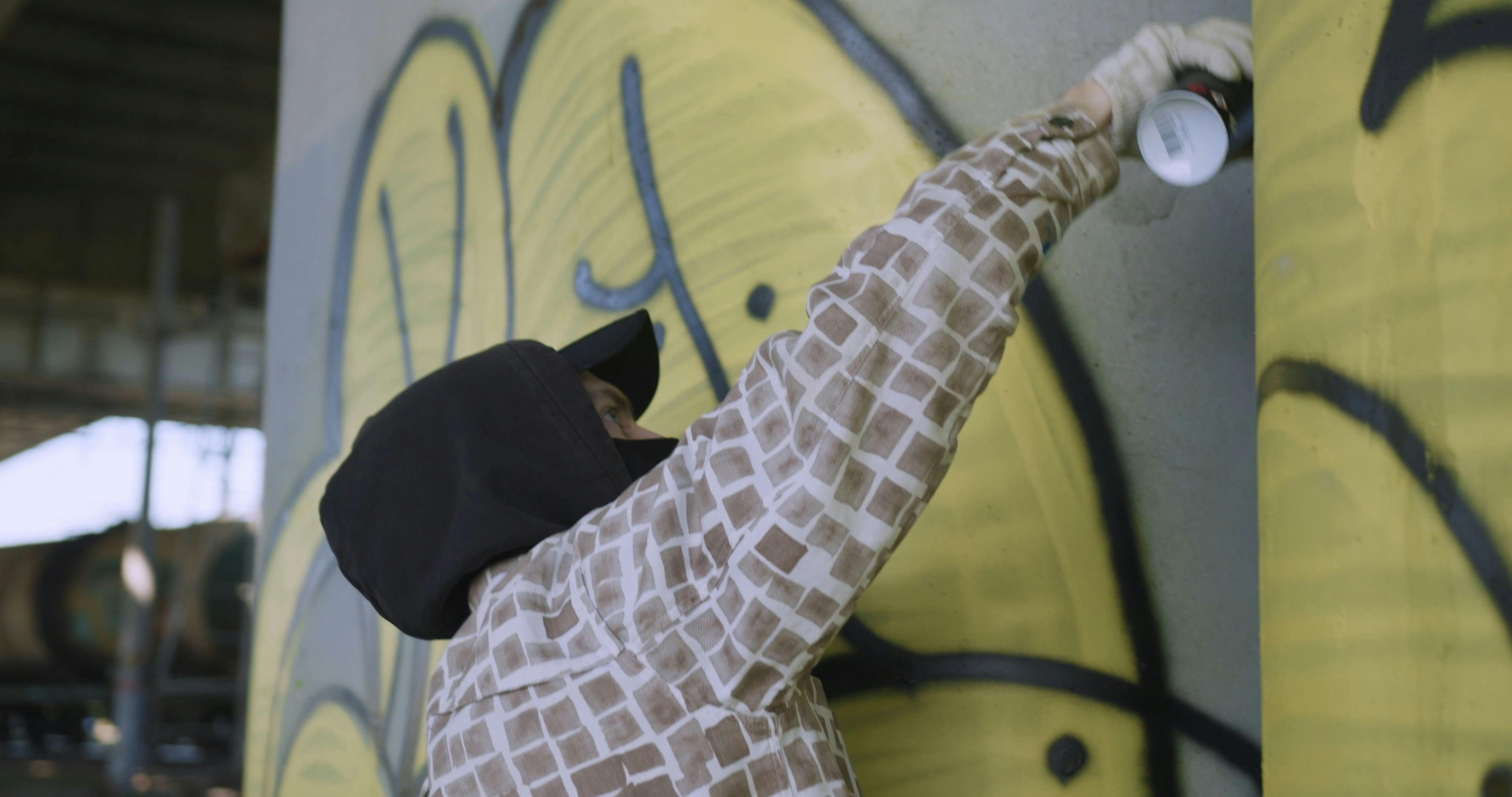 A Man Doing Graffiti Art on a Wall · Free Stock Video