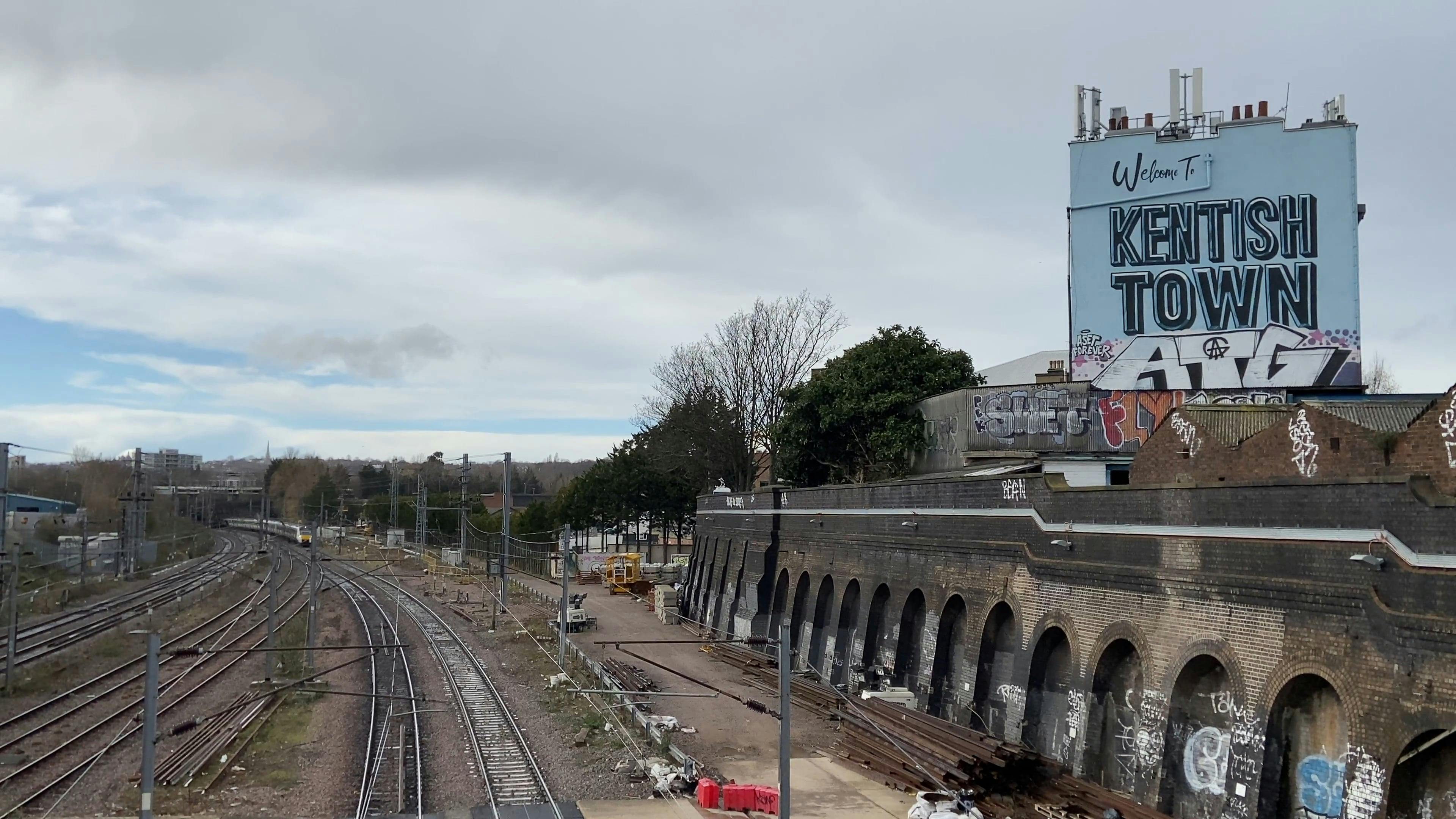 A Cargo Train With Graffiti Art On Its Cargo Container Traveling On A ...