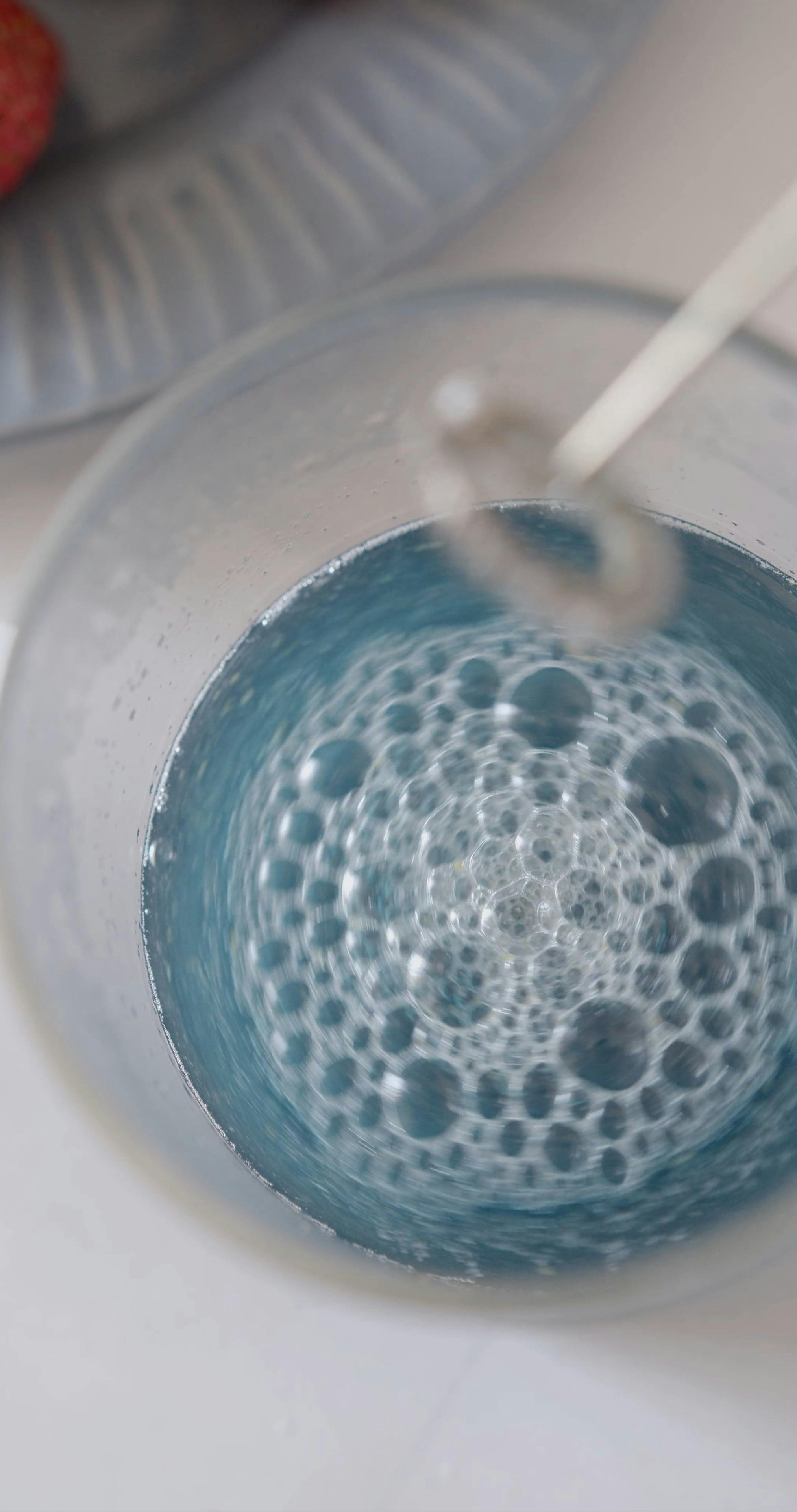 A Person Stiring Liquid in a Clear Glass Free Stock Video Footage ...