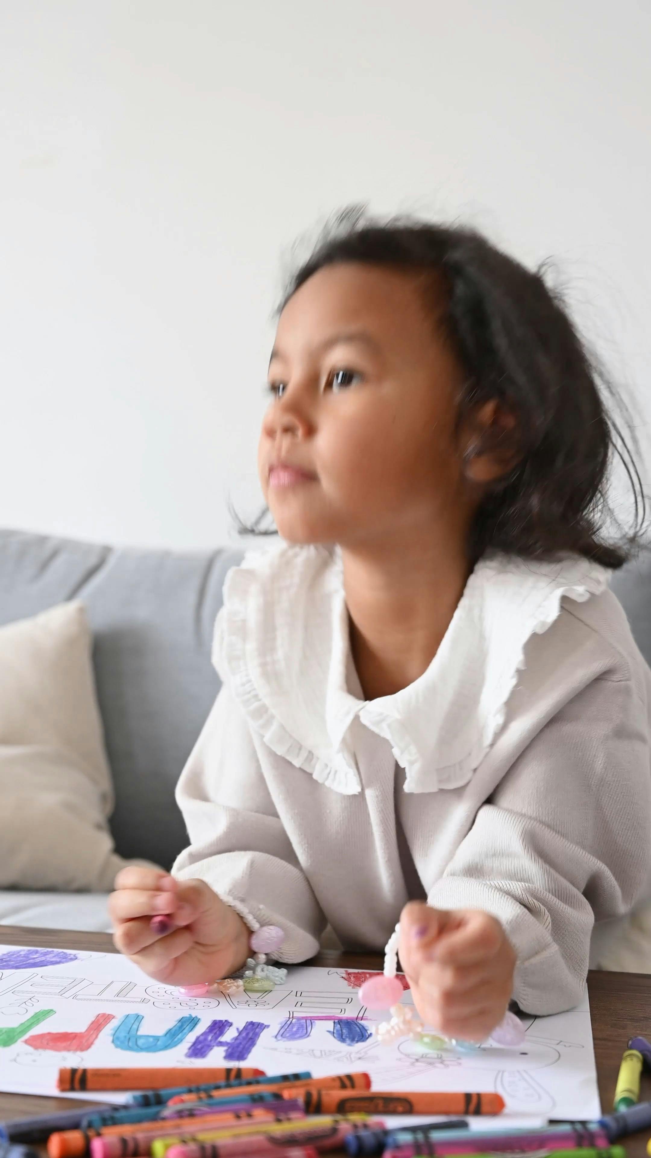 Little Girl Coloring on White Paper · Free Stock Video