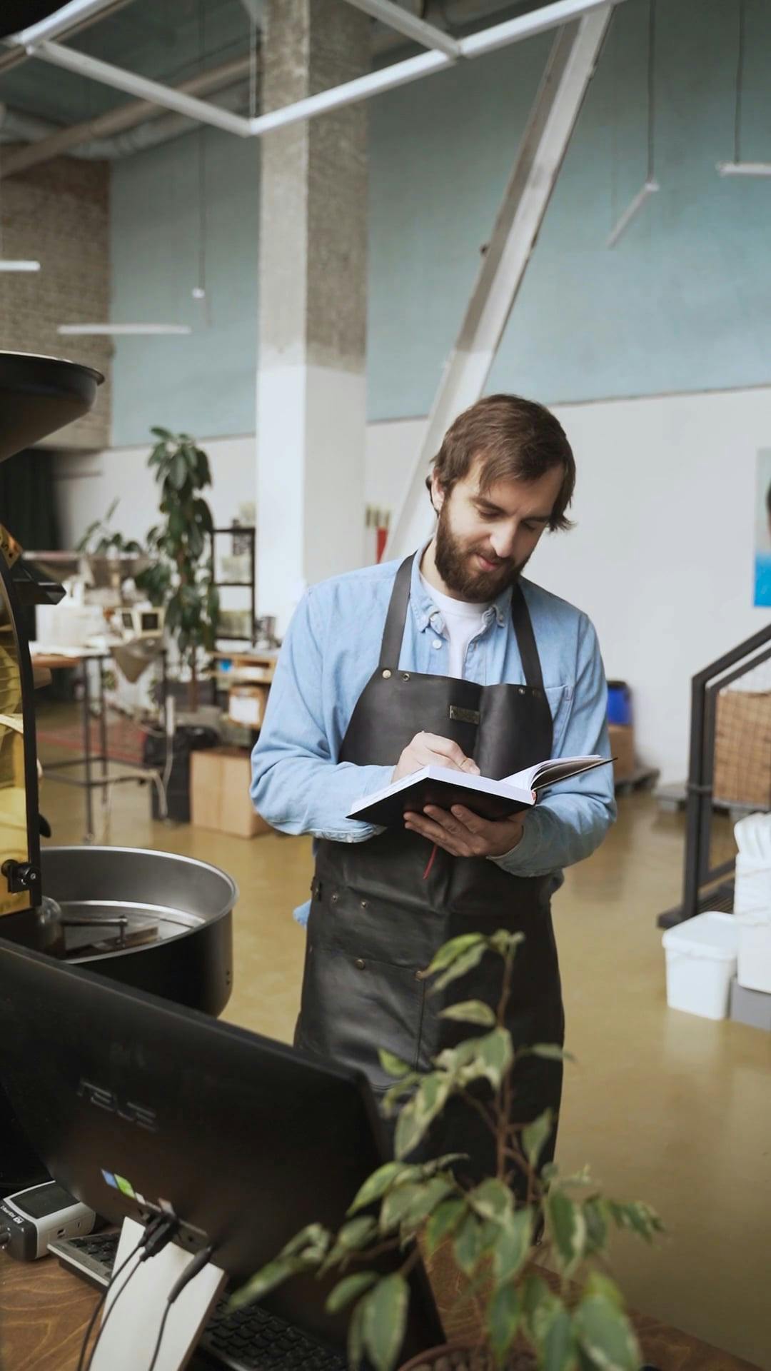 A Man Wearing an Apron Writing in a Notebook Free Stock Video Footage ...