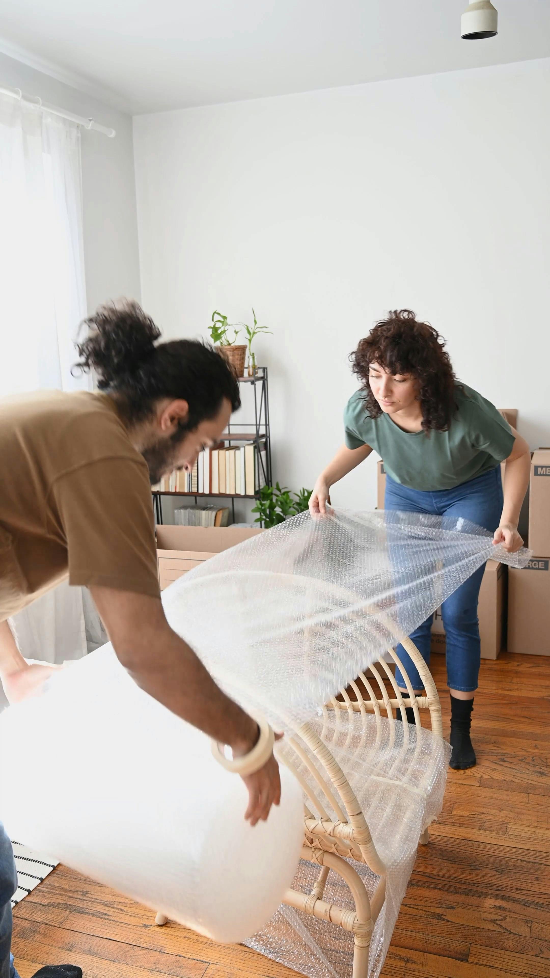Man and Woman Wrapping a Chair with Bubble Wrap Free Stock Video ...