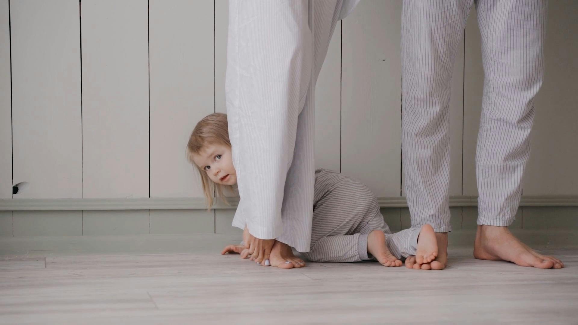 A Toddler Crawling on the Floor While His Parents are Standing · Free ...