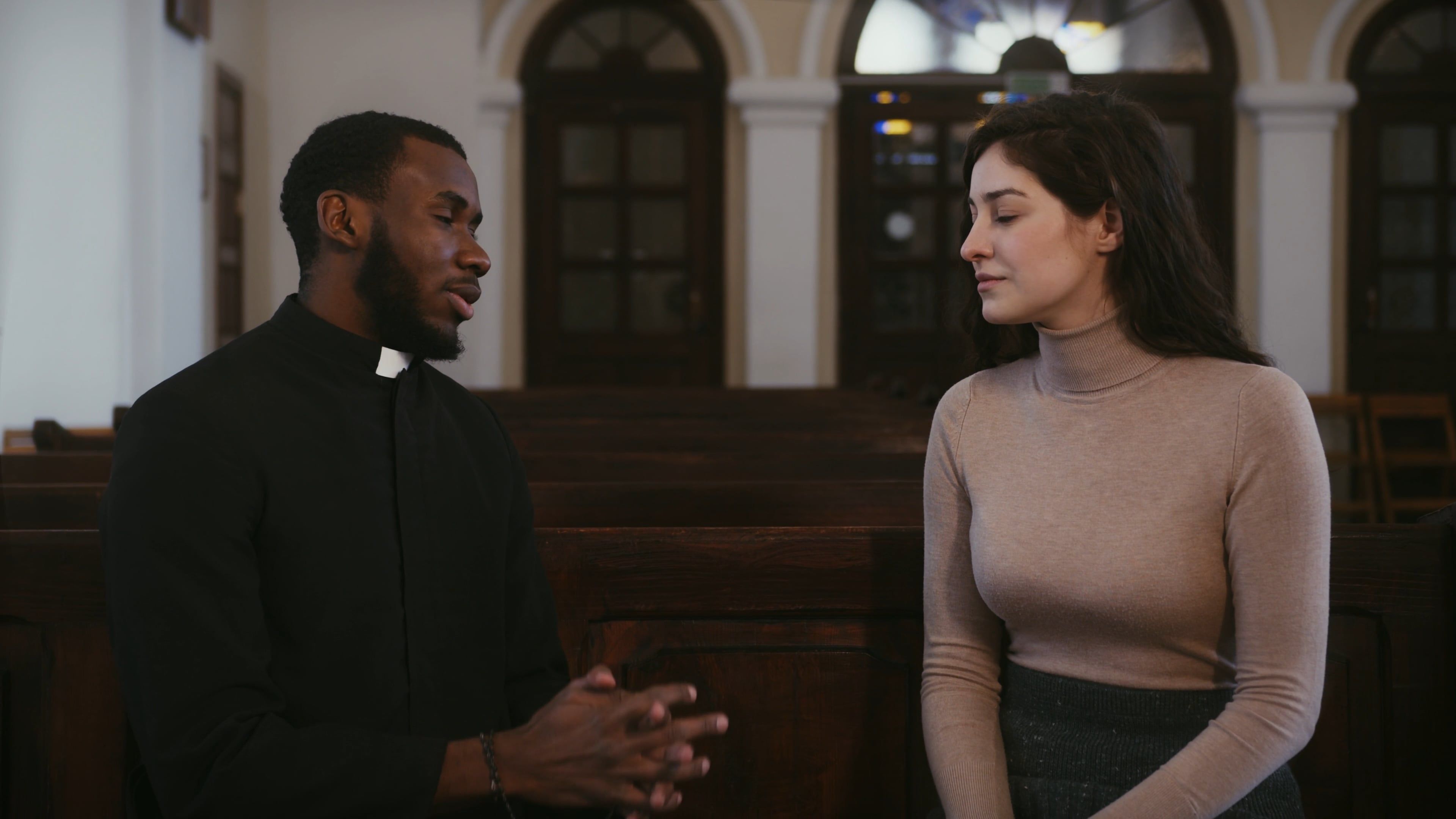 Priest Advising Young Woman · Free Stock Video