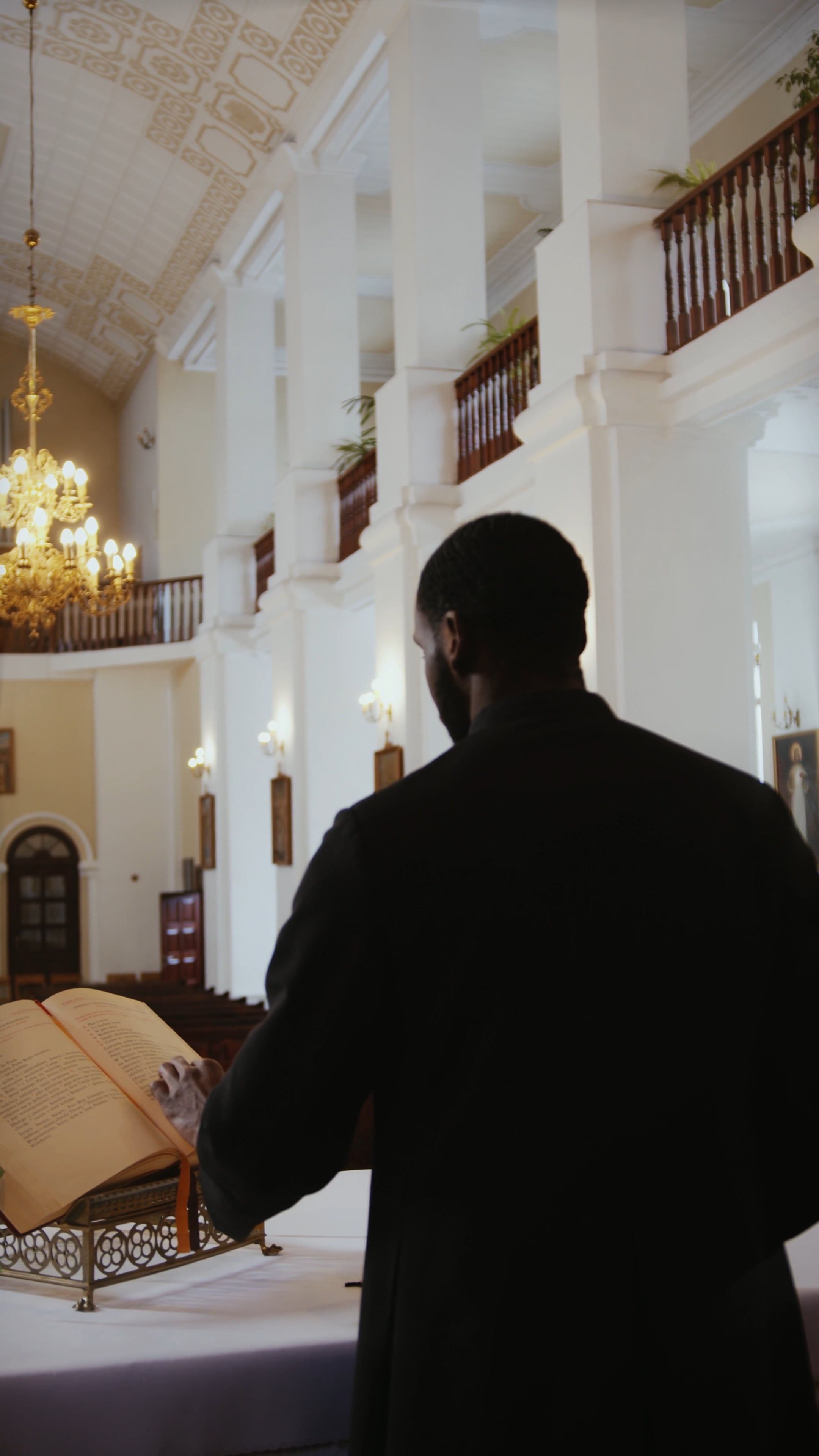 Back View of a Priest Pointing at a Bible on an Altar Free Stock Video ...