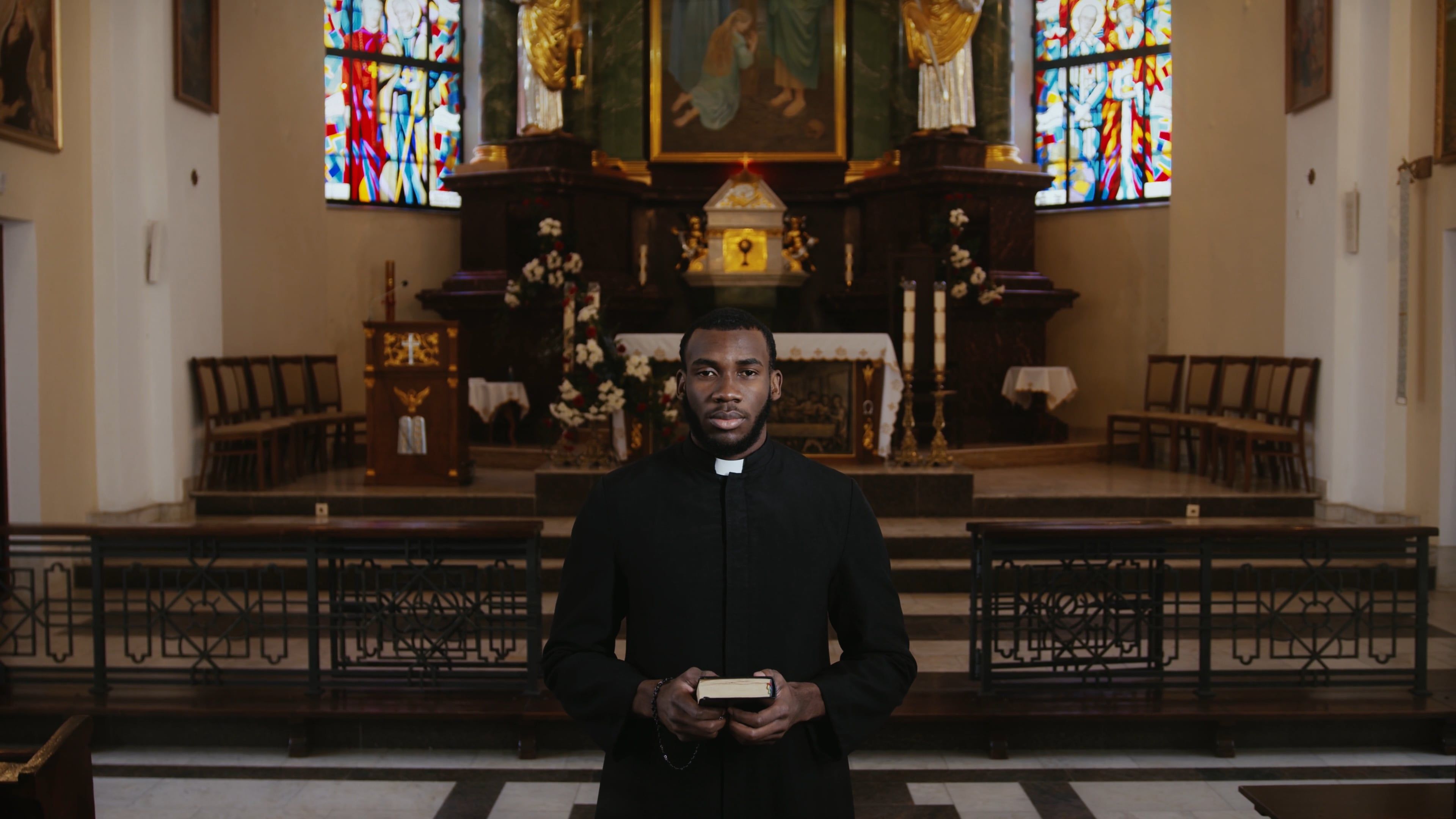 Priest Holding a Bible in Church · Free Stock Video