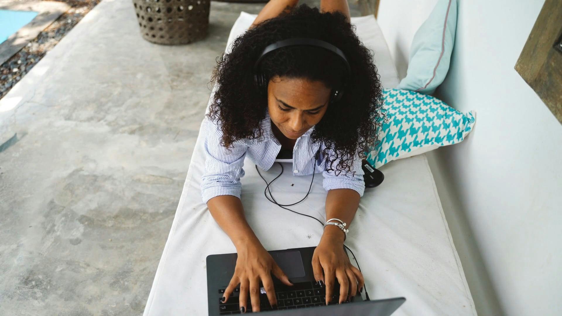 Woman Listening to Music while Using Her Laptop · Free Stock Video