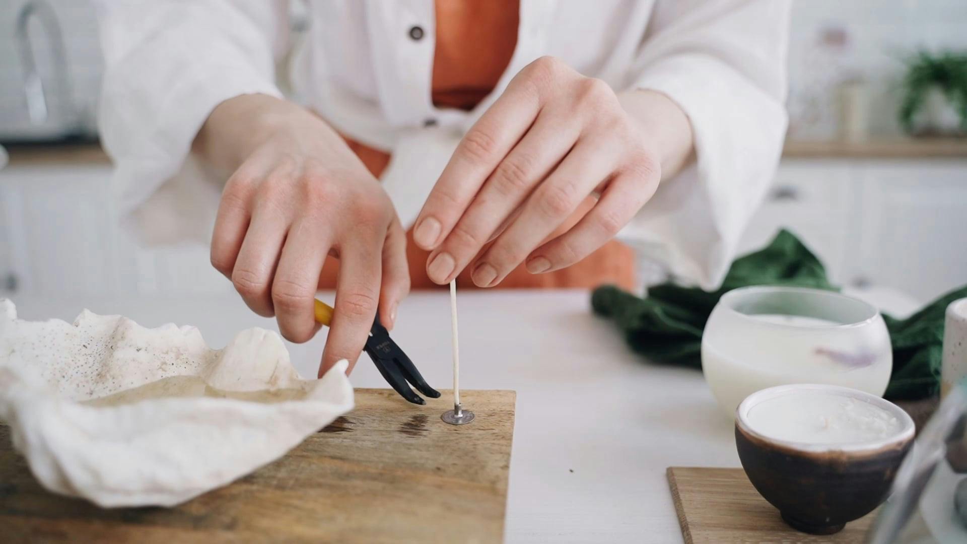 Securing a Candle Wick in Place · Free Stock Video