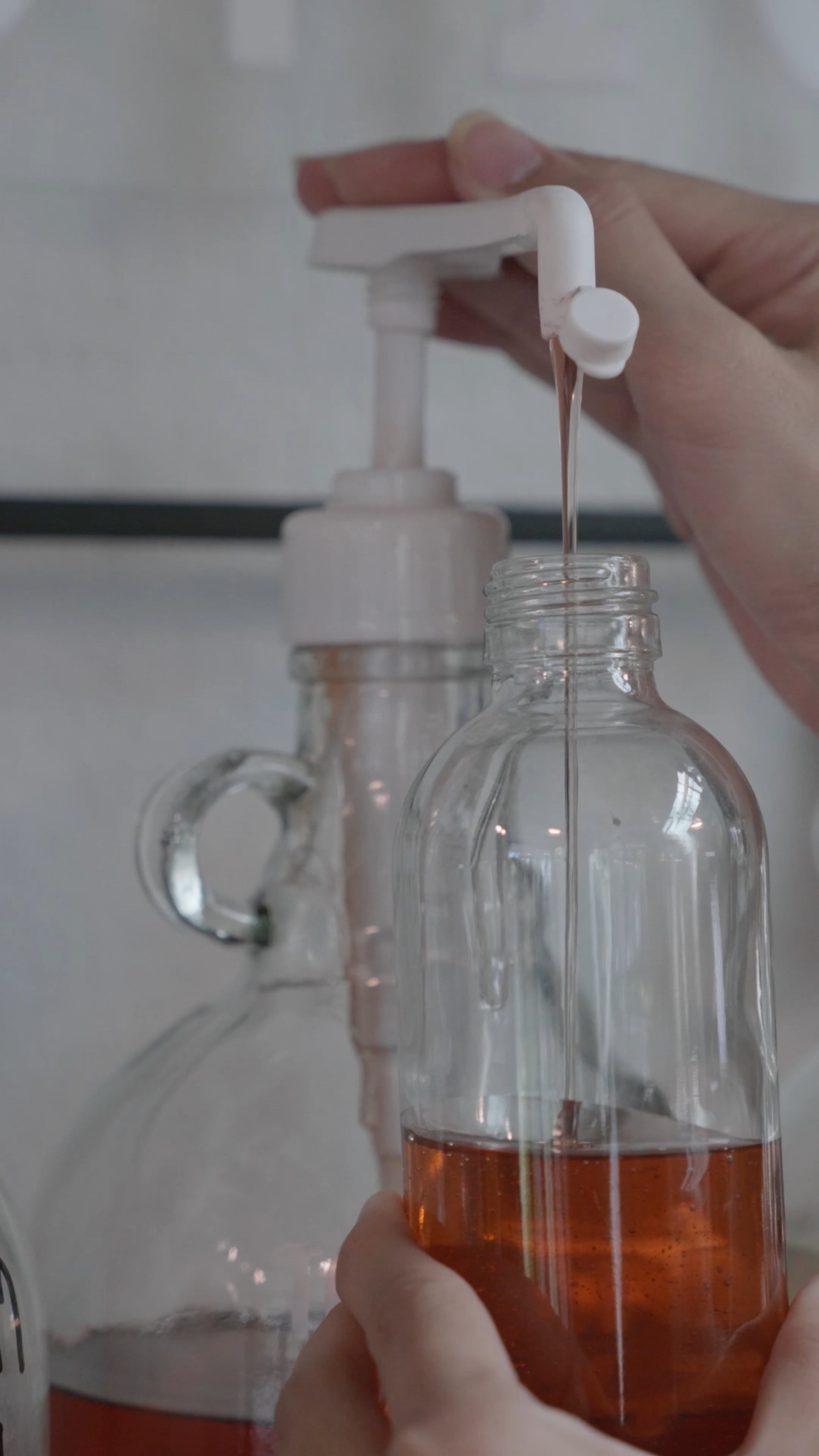 Refilling a Glass Bottle with Shampoo · Free Stock Video