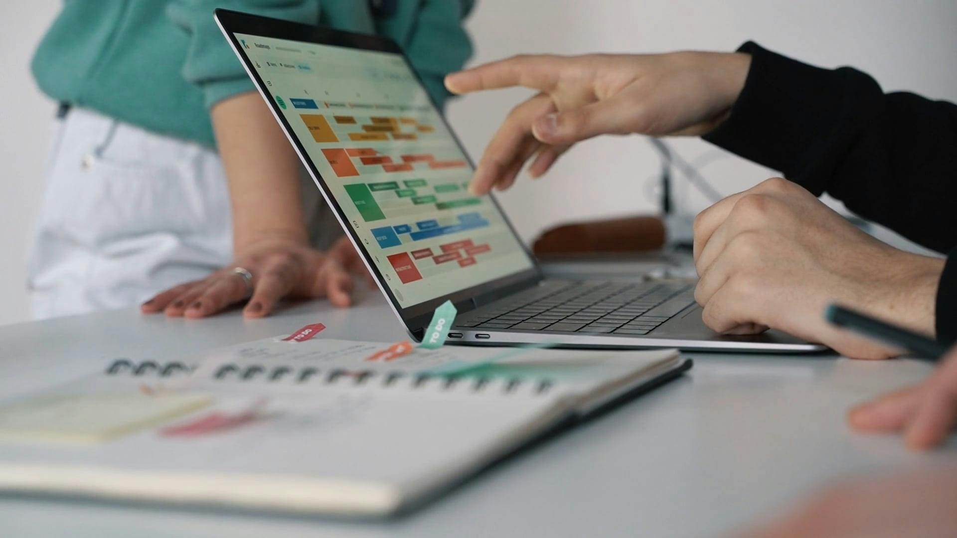 People Discussing Chart on Computer Screen · Free Stock Video