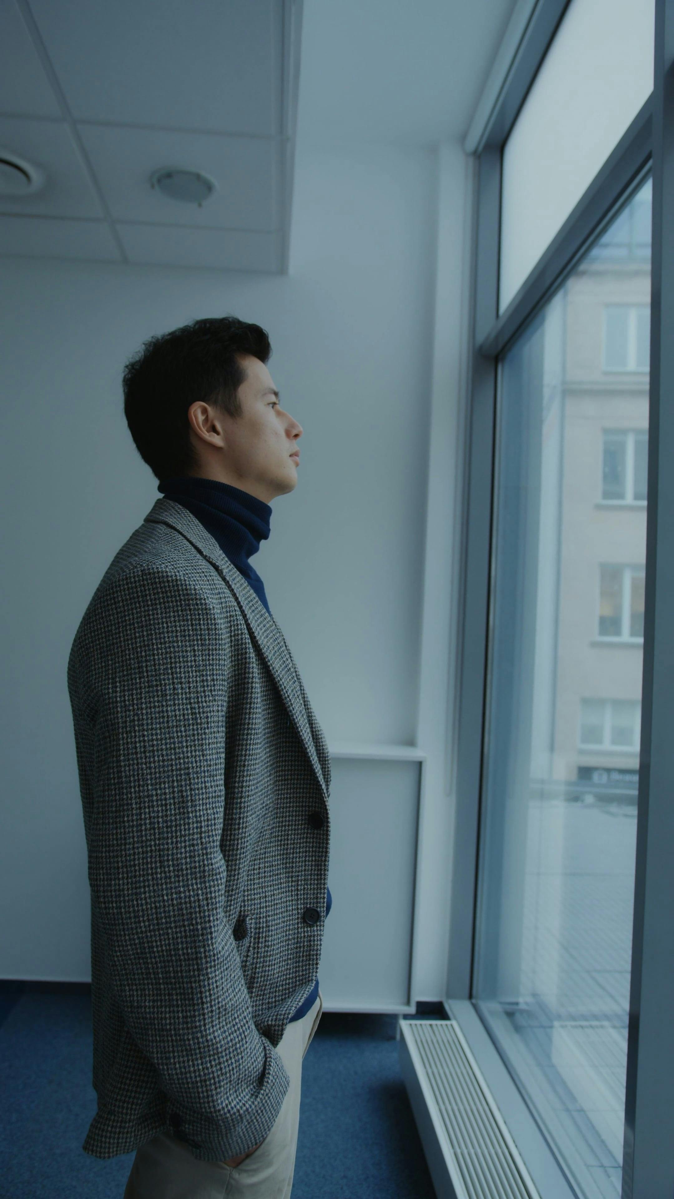 Man Standing by the Window Looking Outside Free Stock Video Footage ...