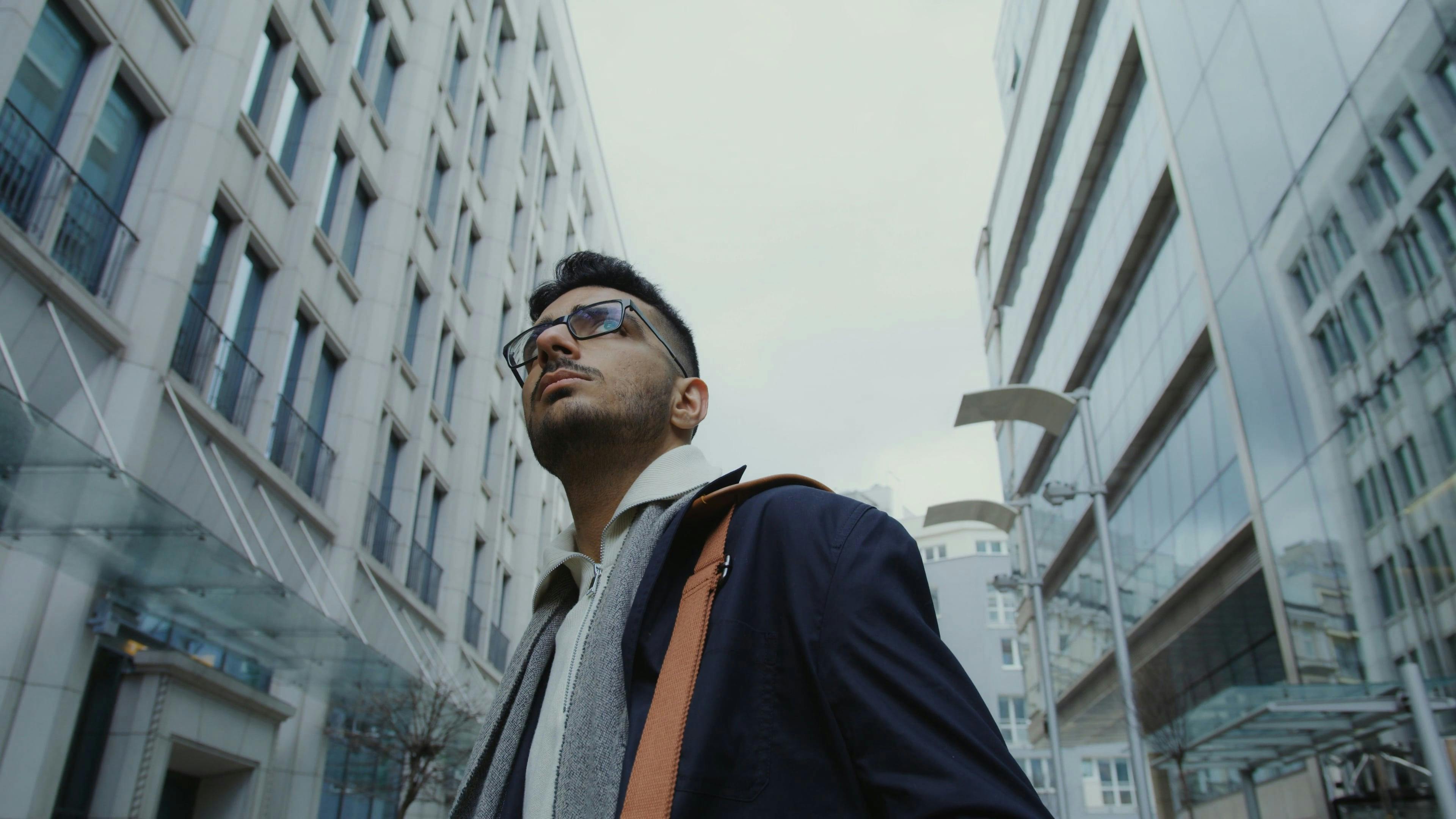 Man Looking Around High-Rise Buildings · Free Stock Video