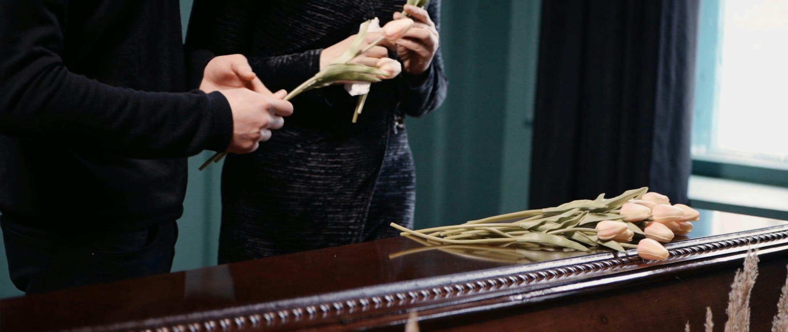 Family In Grief Beside A Coffin · Free Stock Video