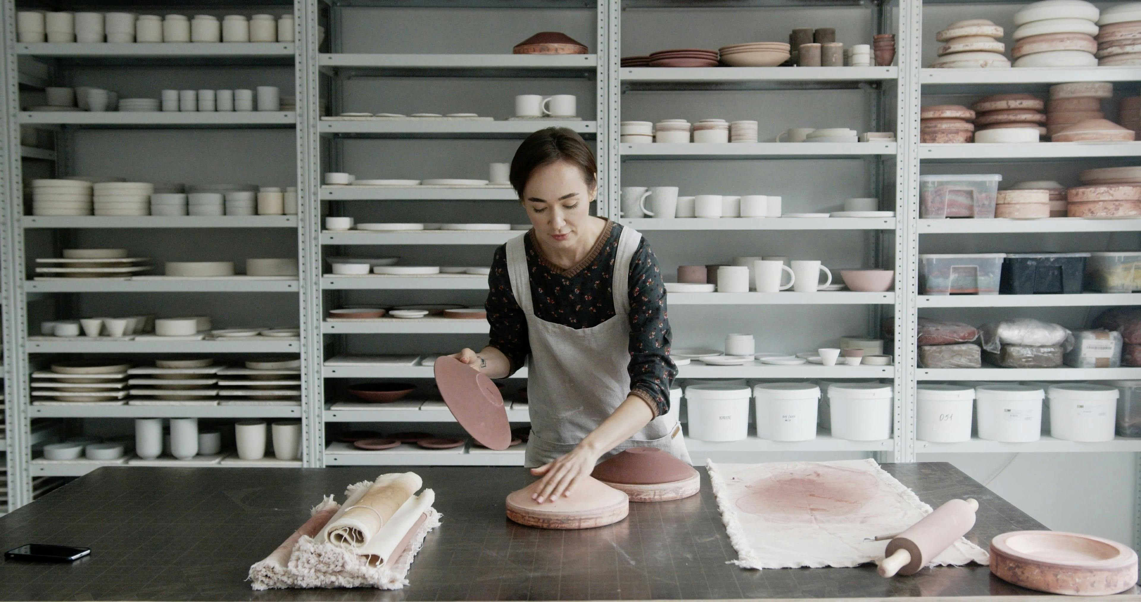 Woman in Apron Molding a Ceramic Plate in Her Workshop · Free Stock Video