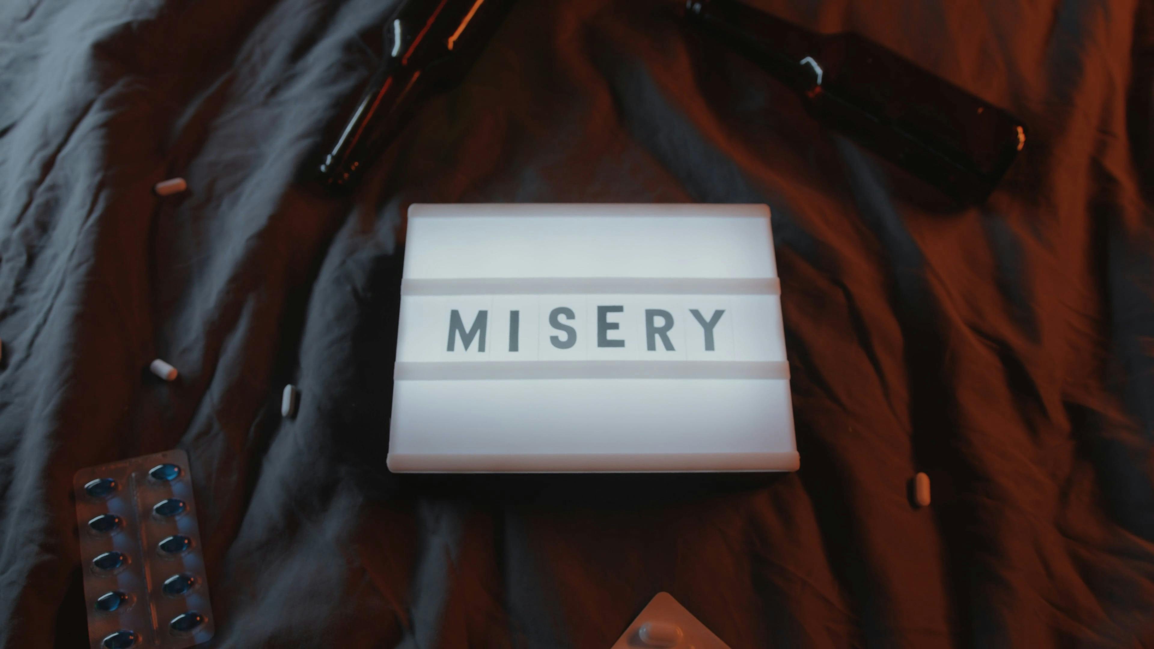 Misery Signage on the Bed with Pills and Bottle Free Stock Video ...
