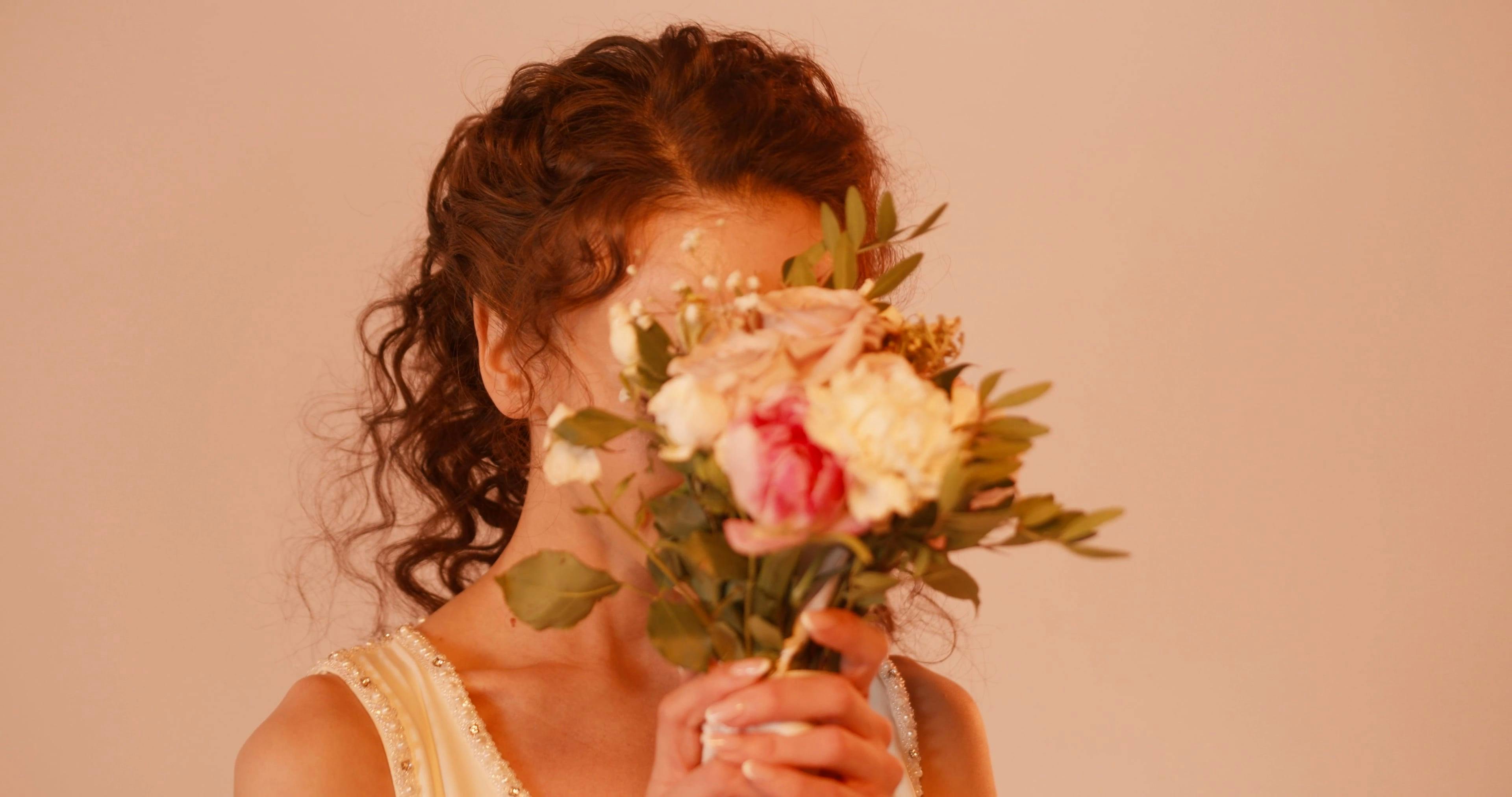 Woman Holding Bouquet of Flowers Covering Her Face Free Stock Video ...