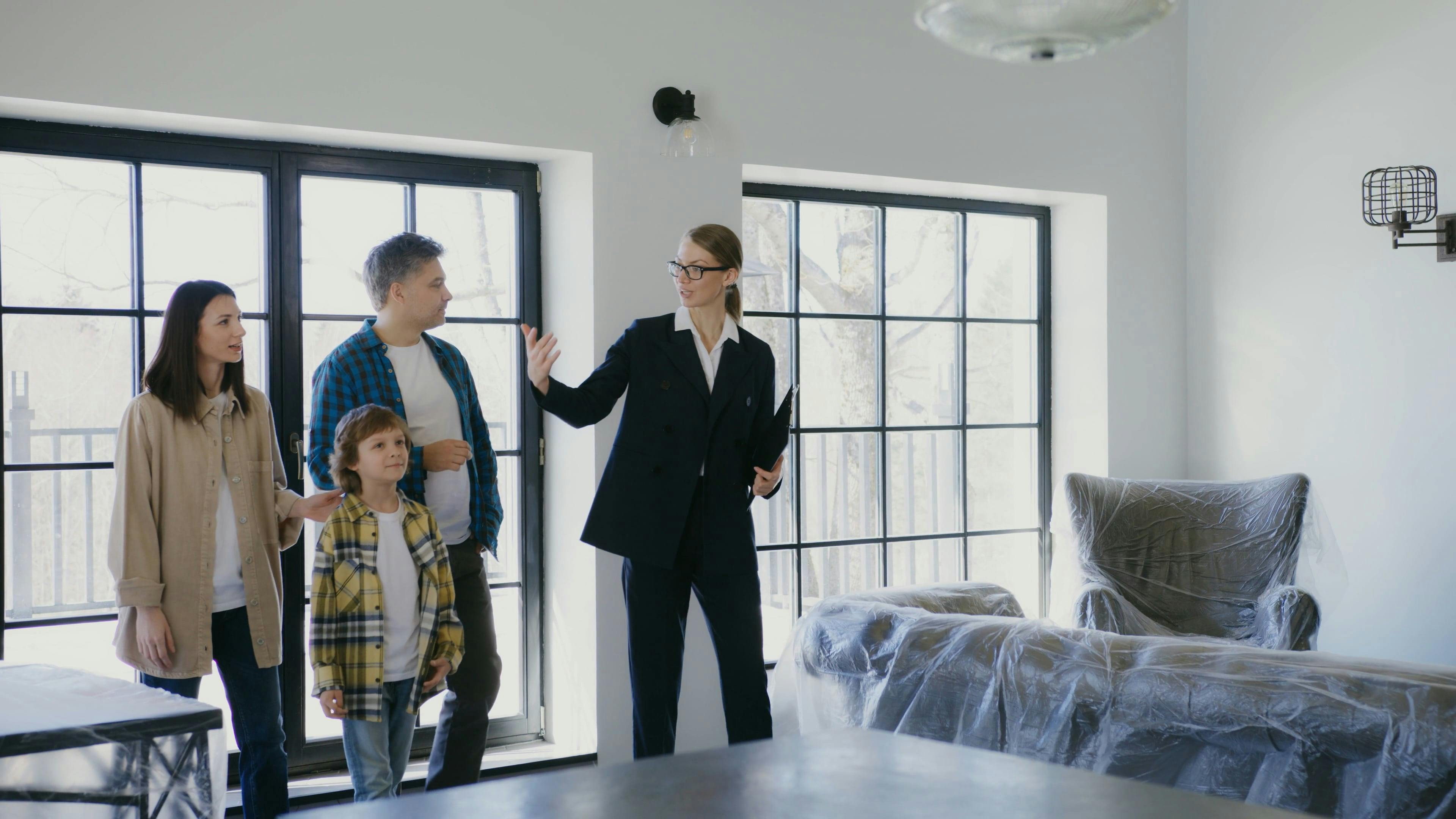 A Real Estate Agent Showing a House to a Family Free Stock Video ...