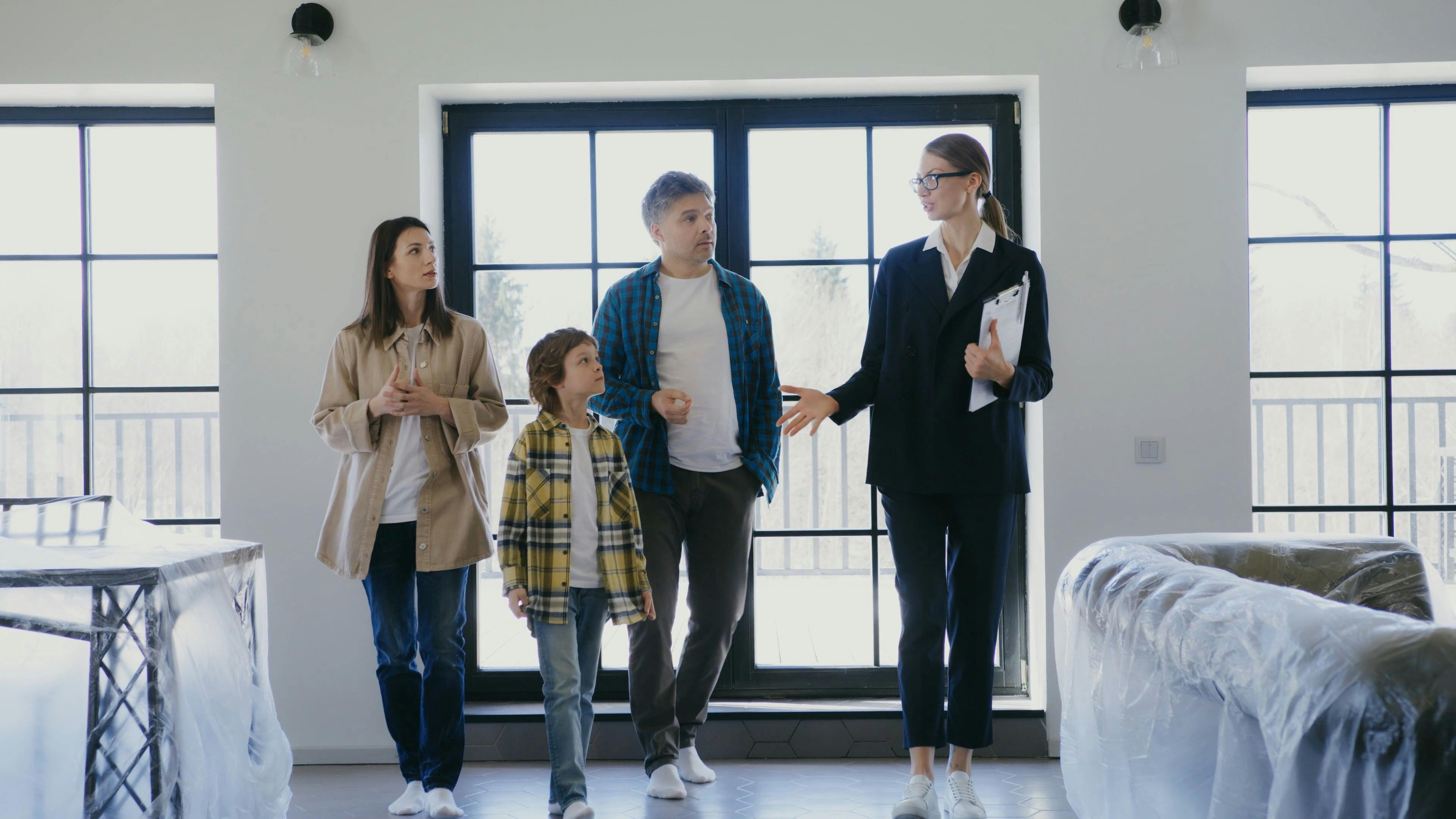 Realtor Showing a Family Around House · Free Stock Video