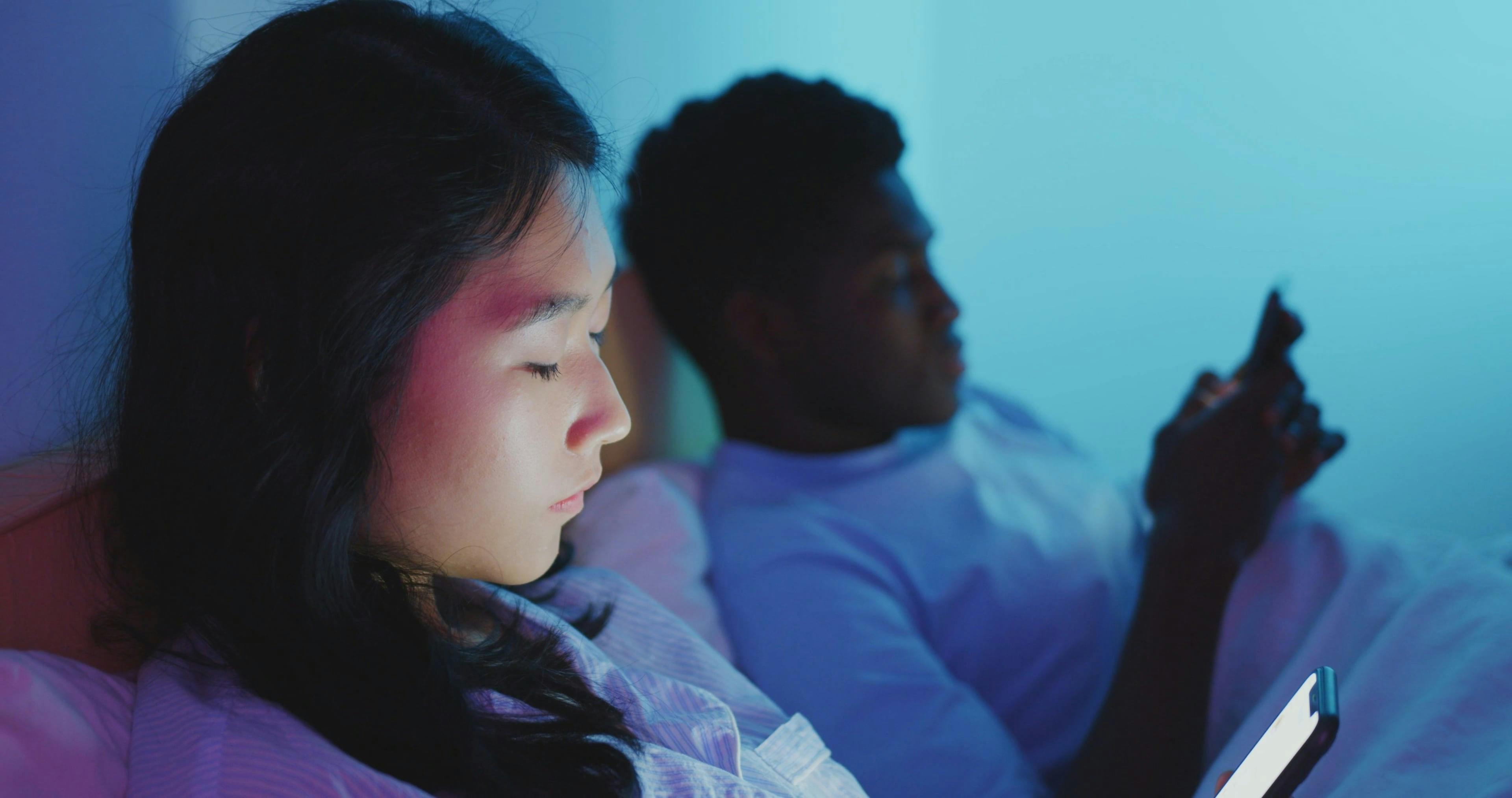 Couple using Smartphone Together in Bed · Free Stock Video