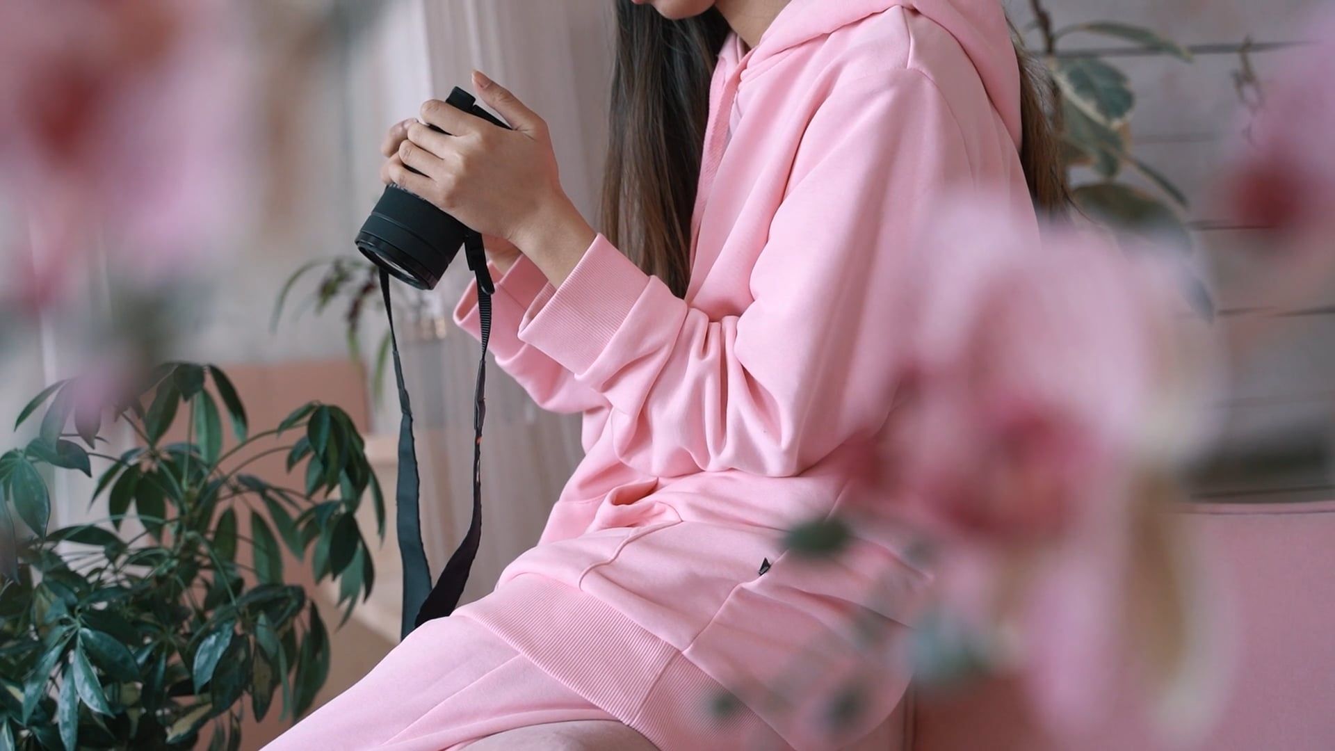 A Woman Holding Camera wearing Pink Hoodie · Free Stock Video