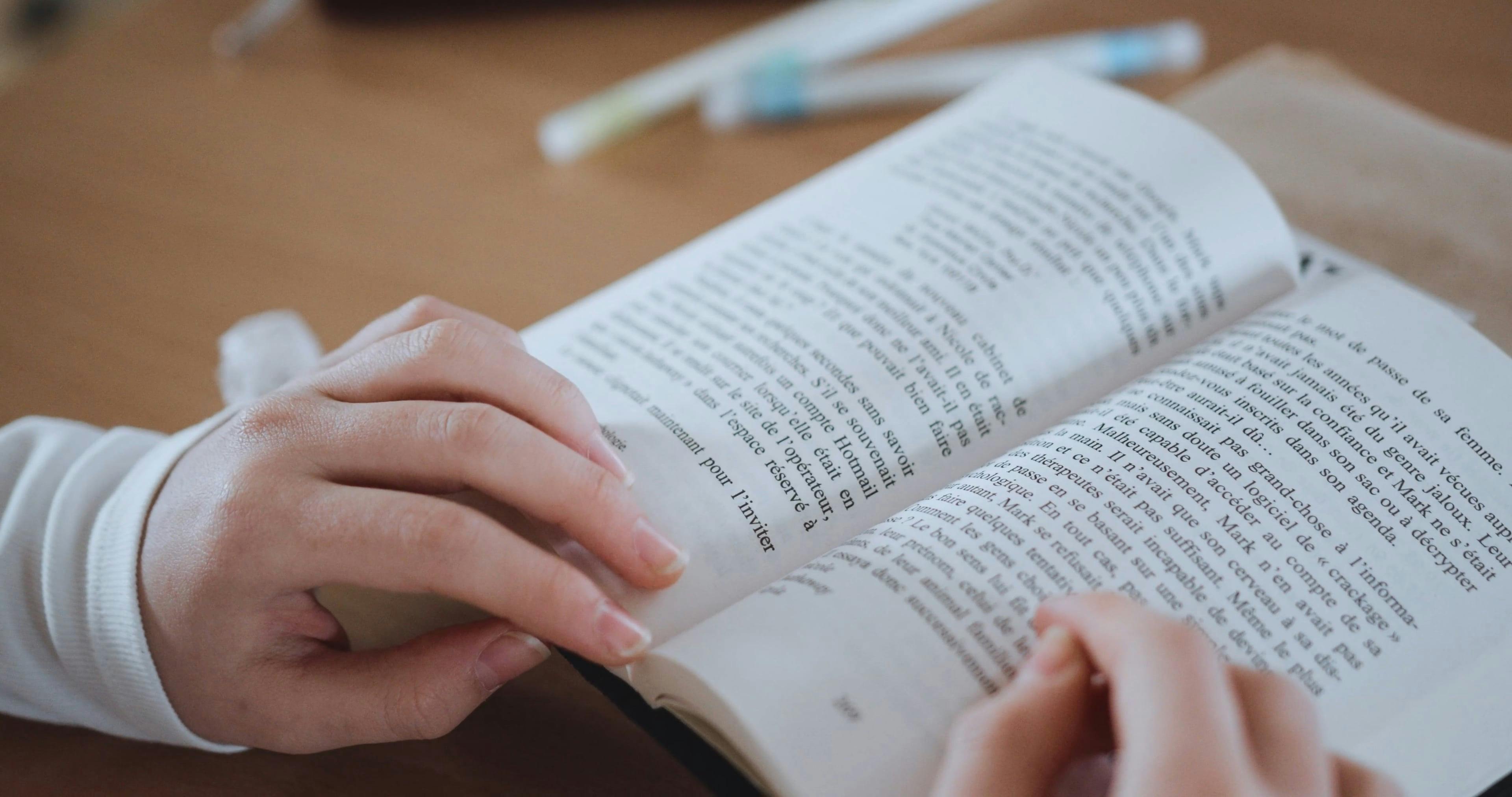 Person Reading a Book and Throwing a Crumpled Paper Free Stock Video ...