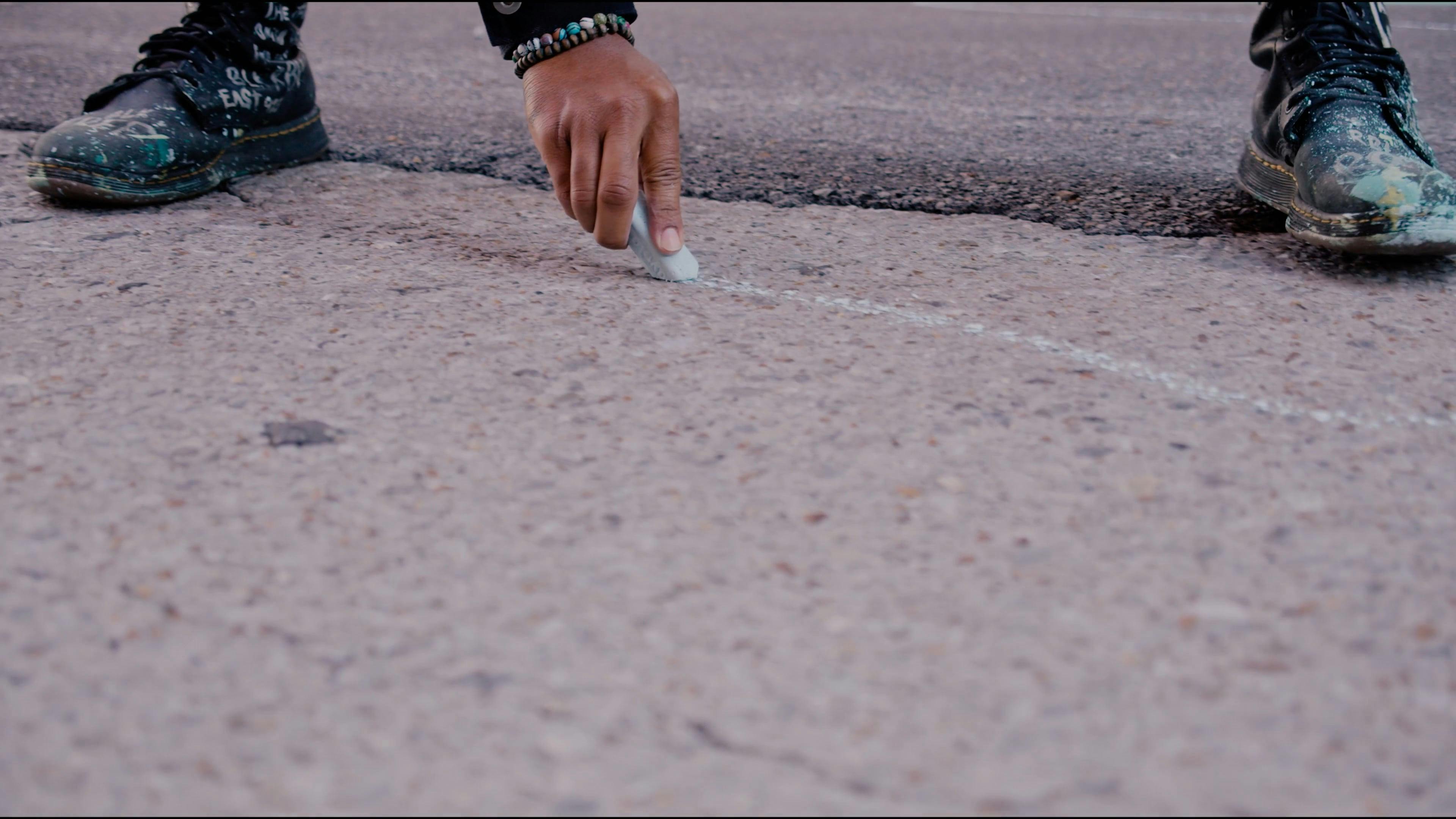 A Man Drawing a Circle Using a Chalk on the Floor Free Stock Video ...