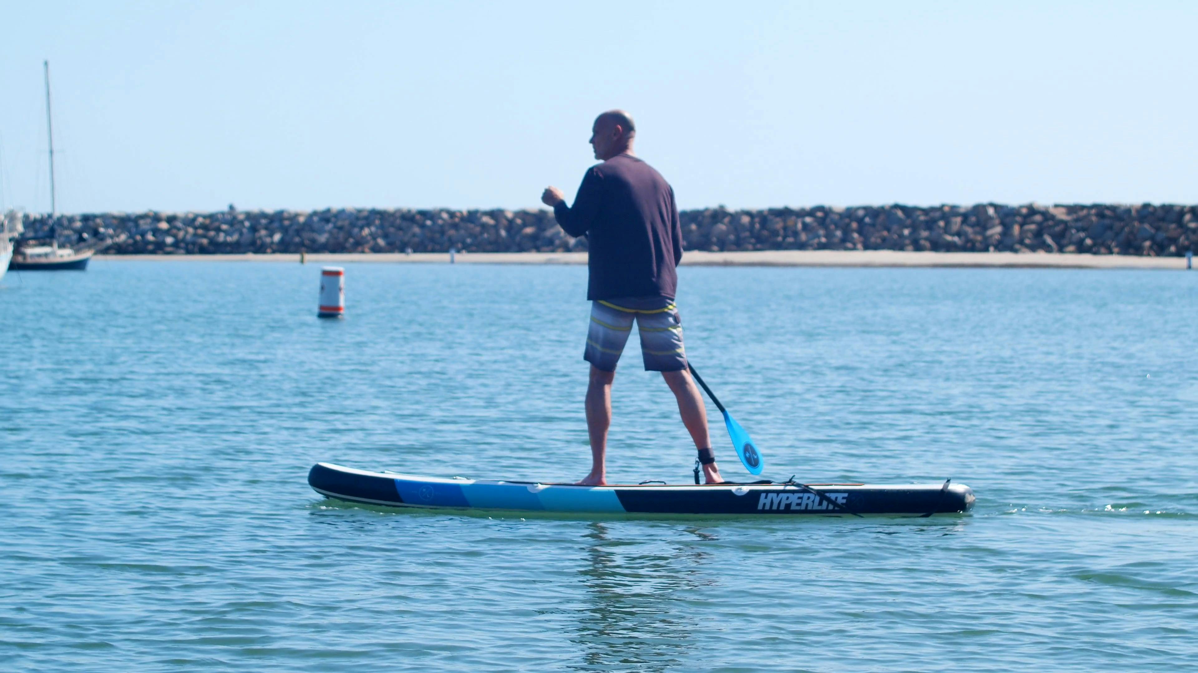 Women Preparing to Ride a Paddle Board · Free Stock Video