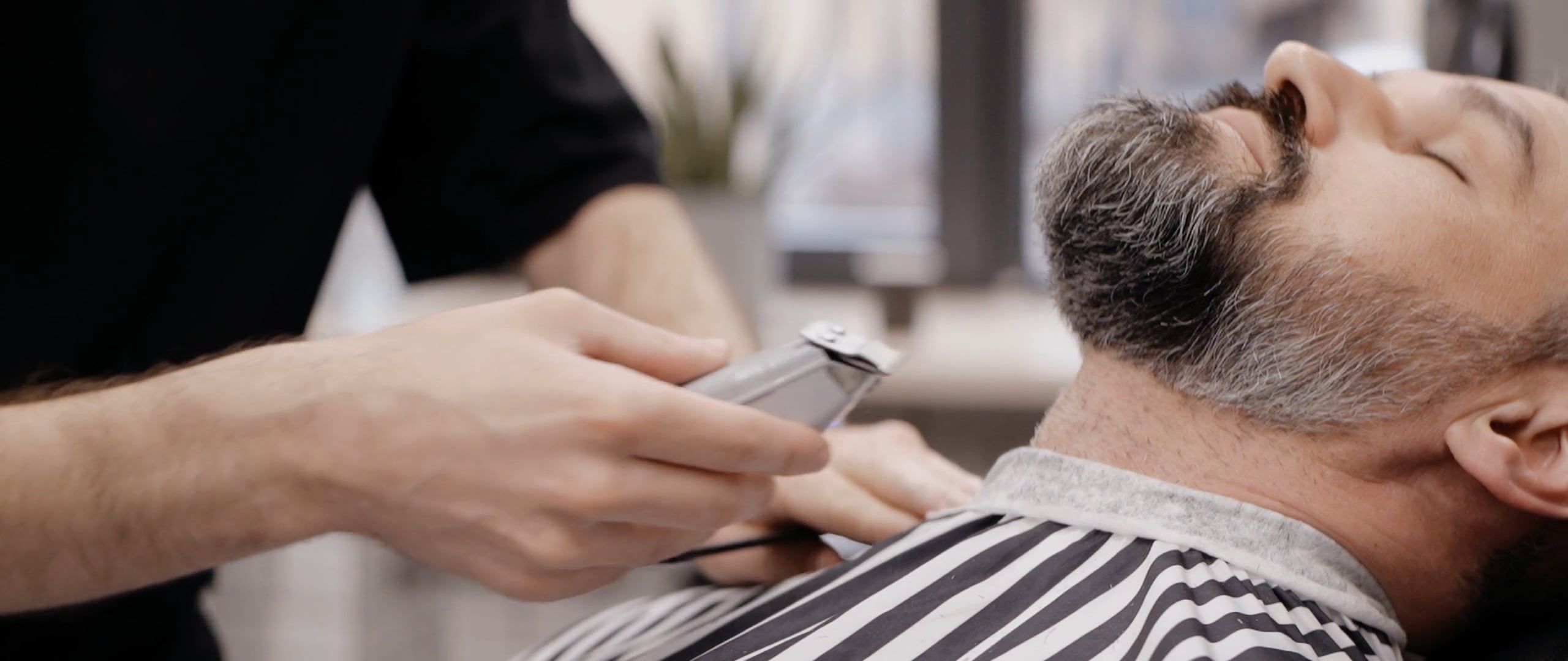 A Barber Trimming the Beard of a Client · Free Stock Video