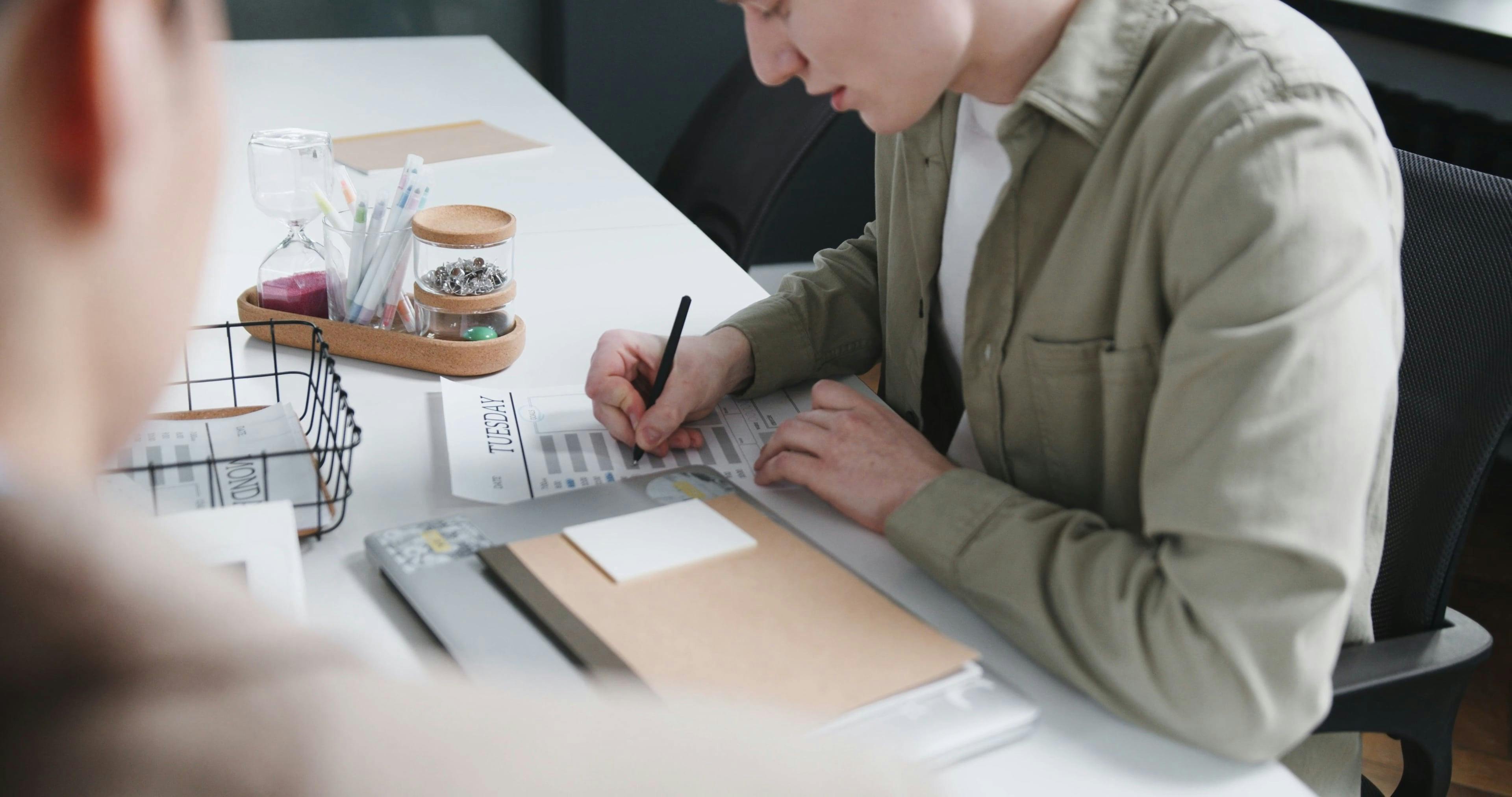 Man Writing on a Planner · Free Stock Video