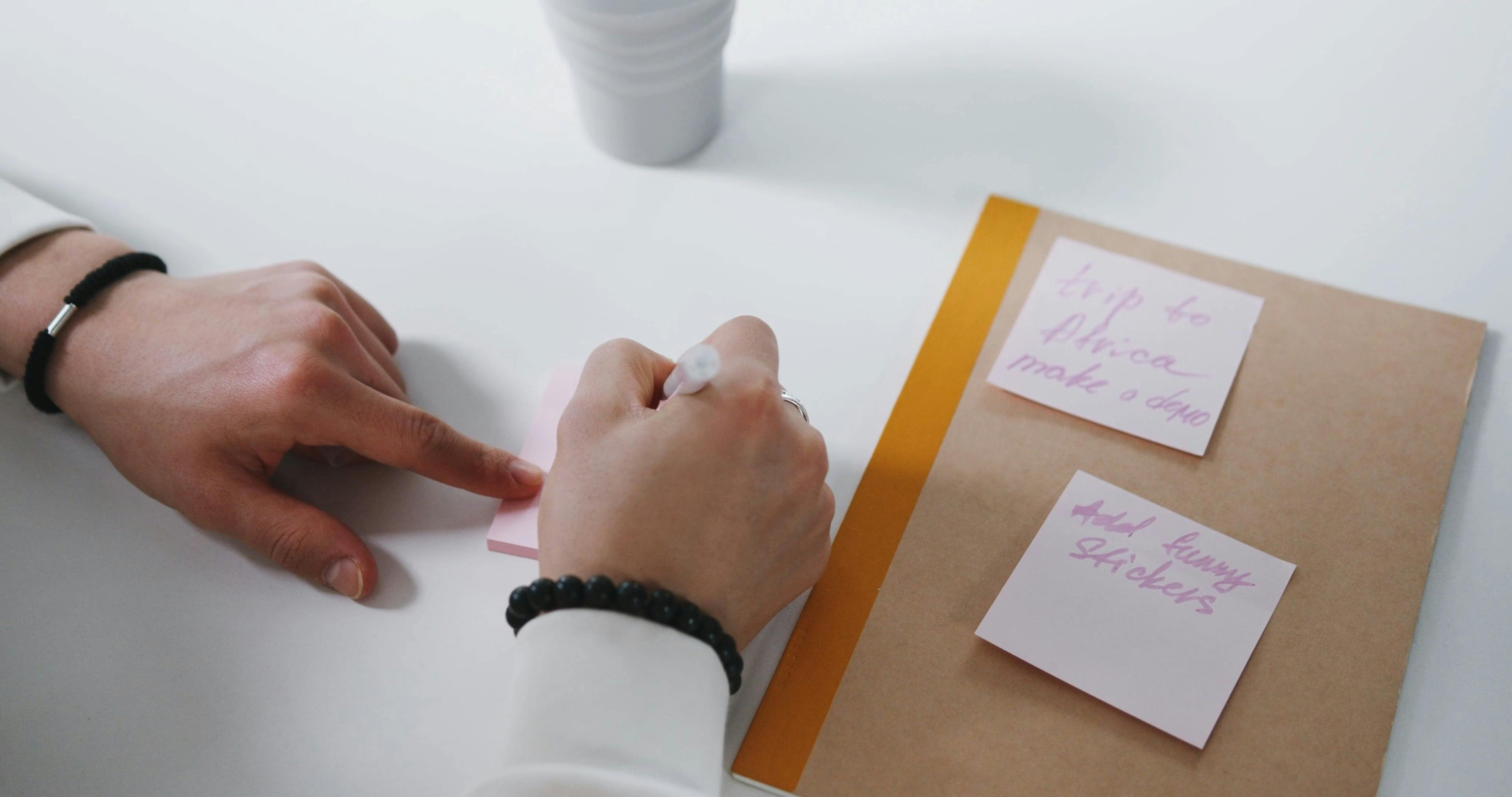 Person Writing on a Sticky Note · Free Stock Video