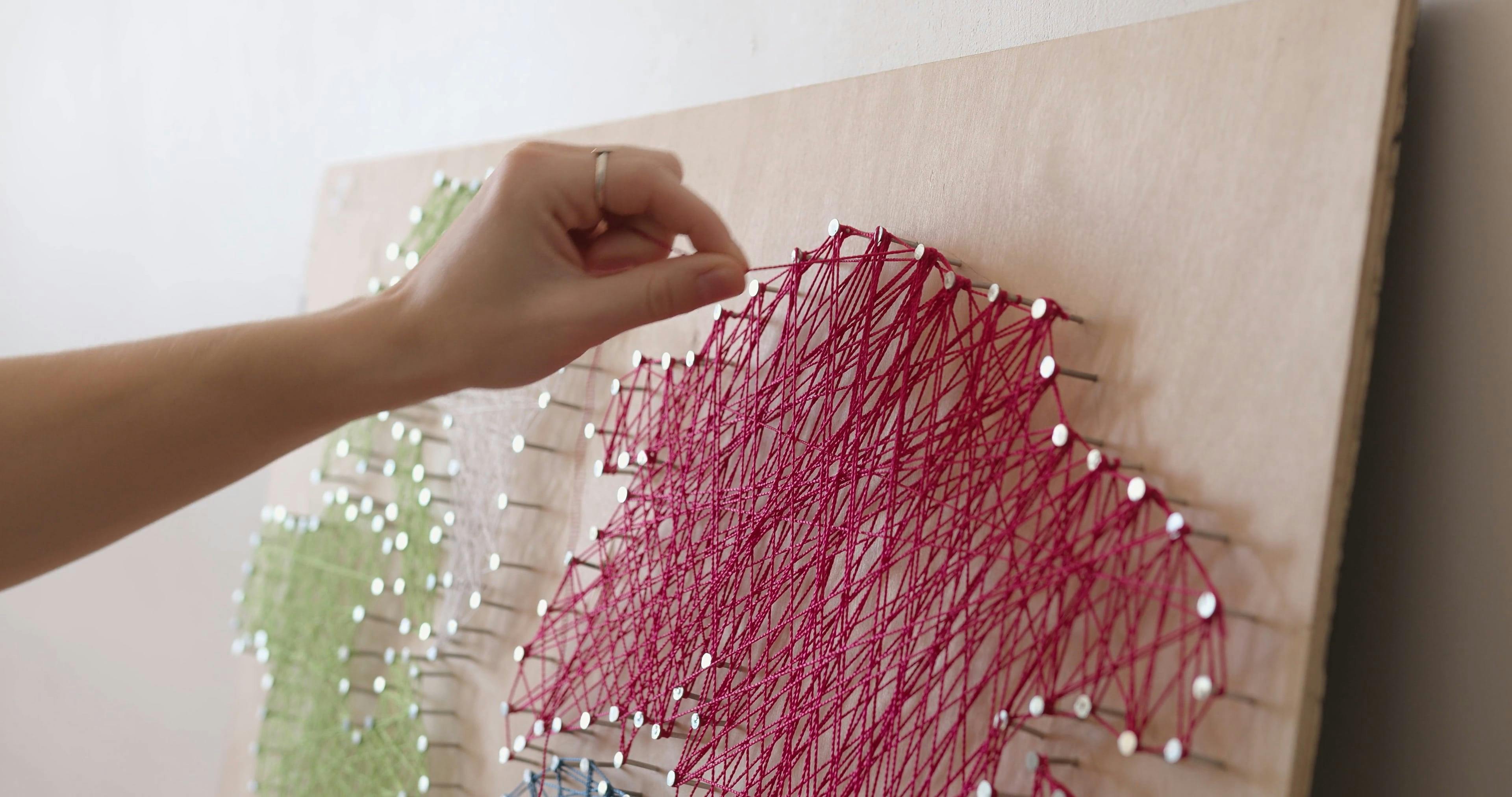 Person Making World Map With Thread · Free Stock Video