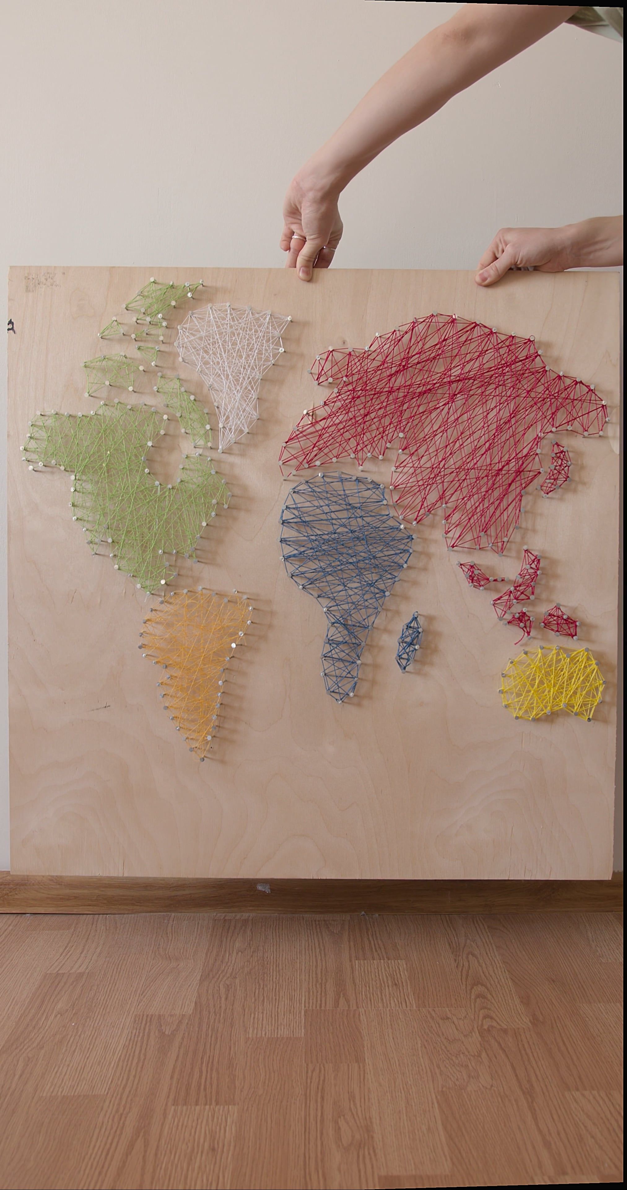 A Person Putting Down a String Art of the World Map · Free Stock Video