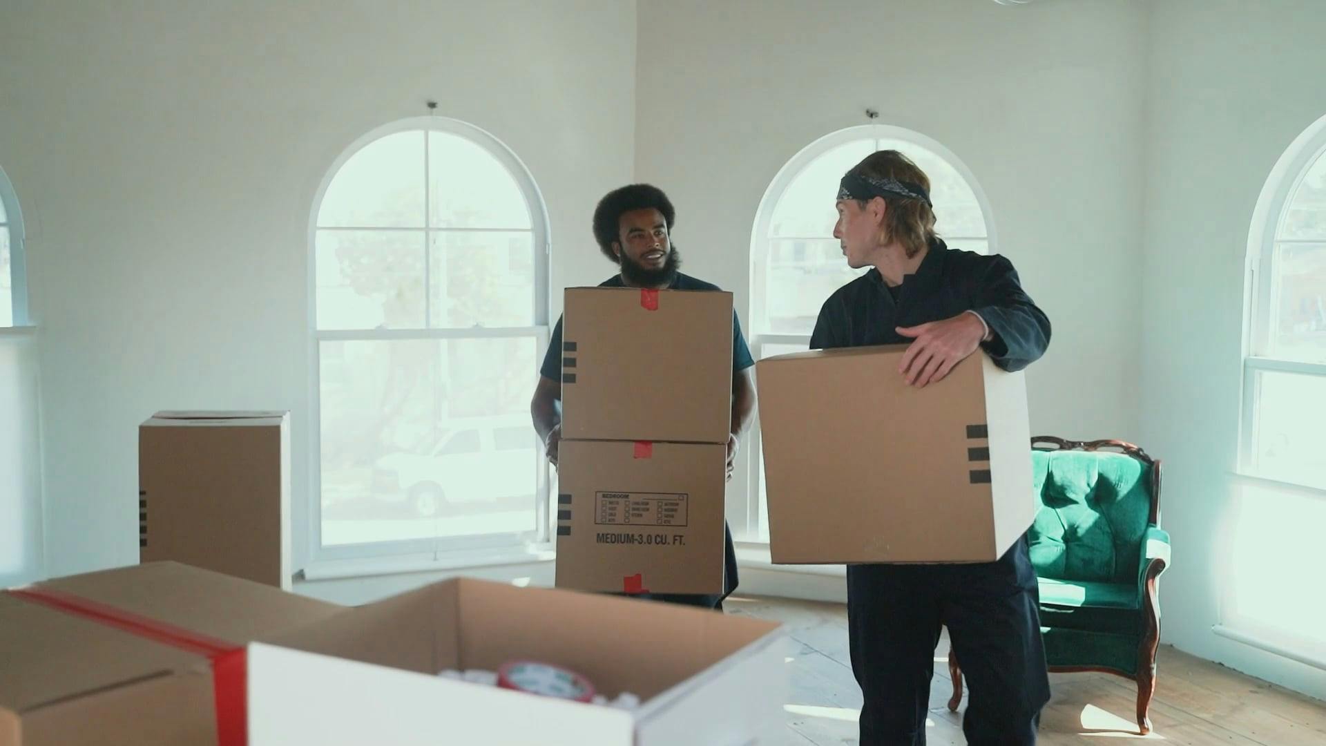 Two Men Carrying Boxes · Free Stock Video