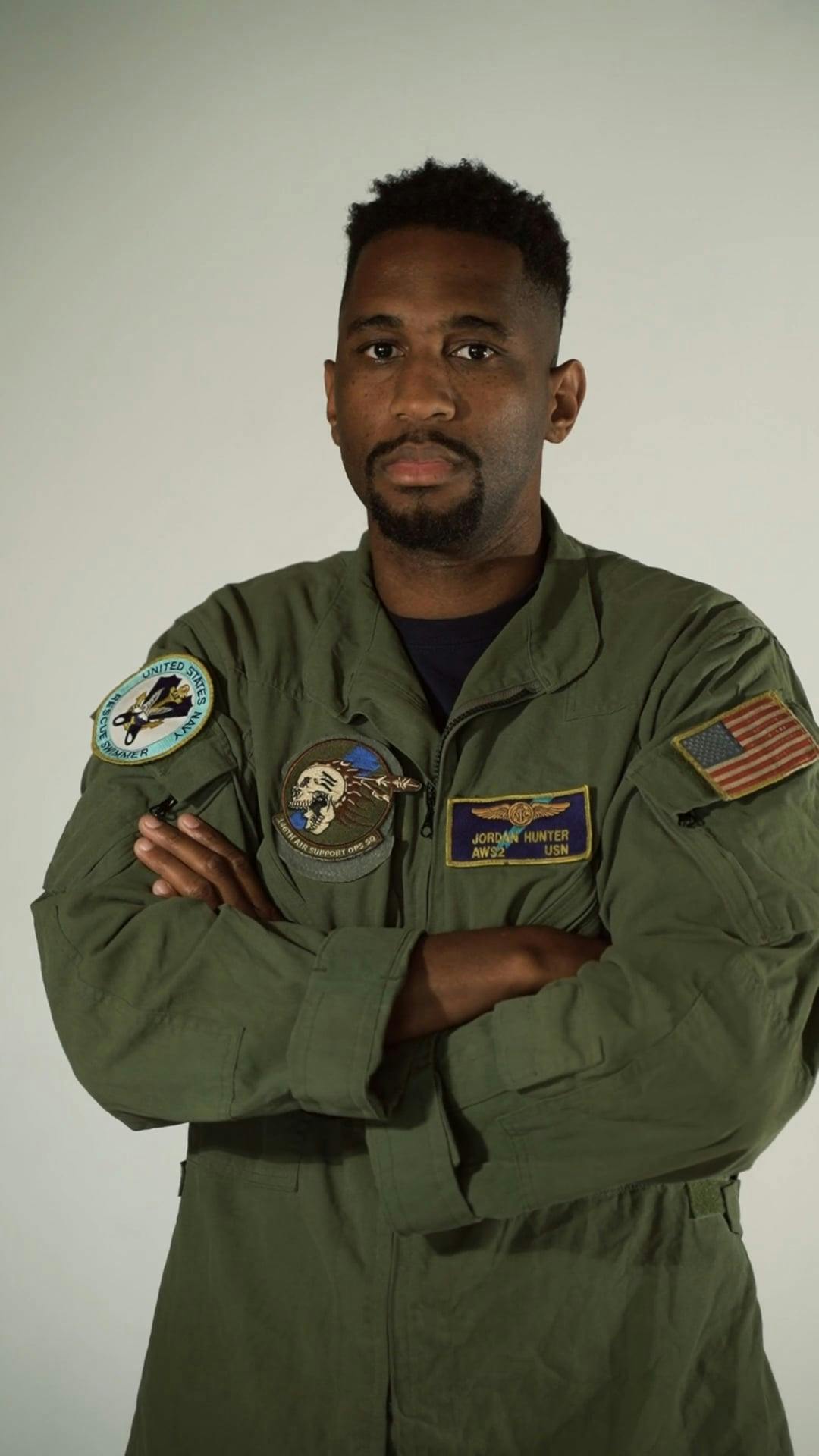 A Army Person on Camouflage Unifom Sitting on a Chair while Holding ...