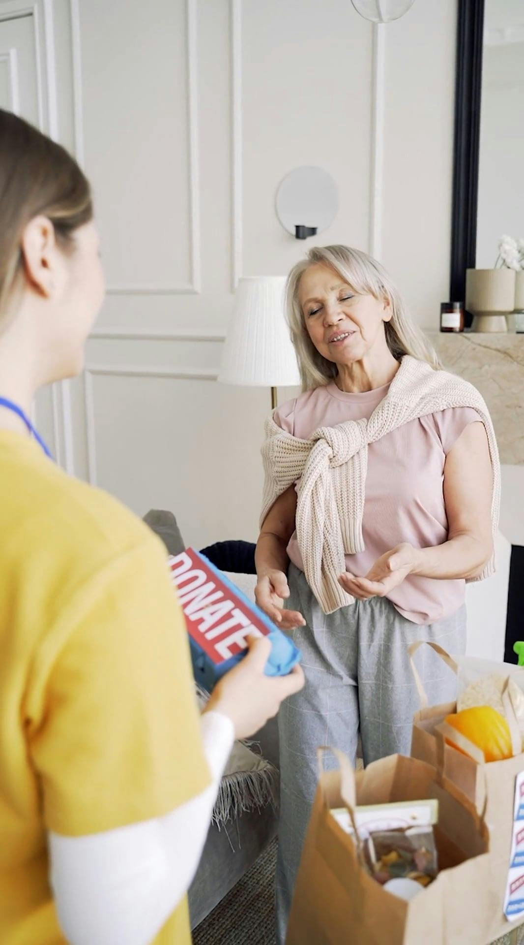 Young Woman Giving Donations to an Elderly Woman Free Stock Video ...