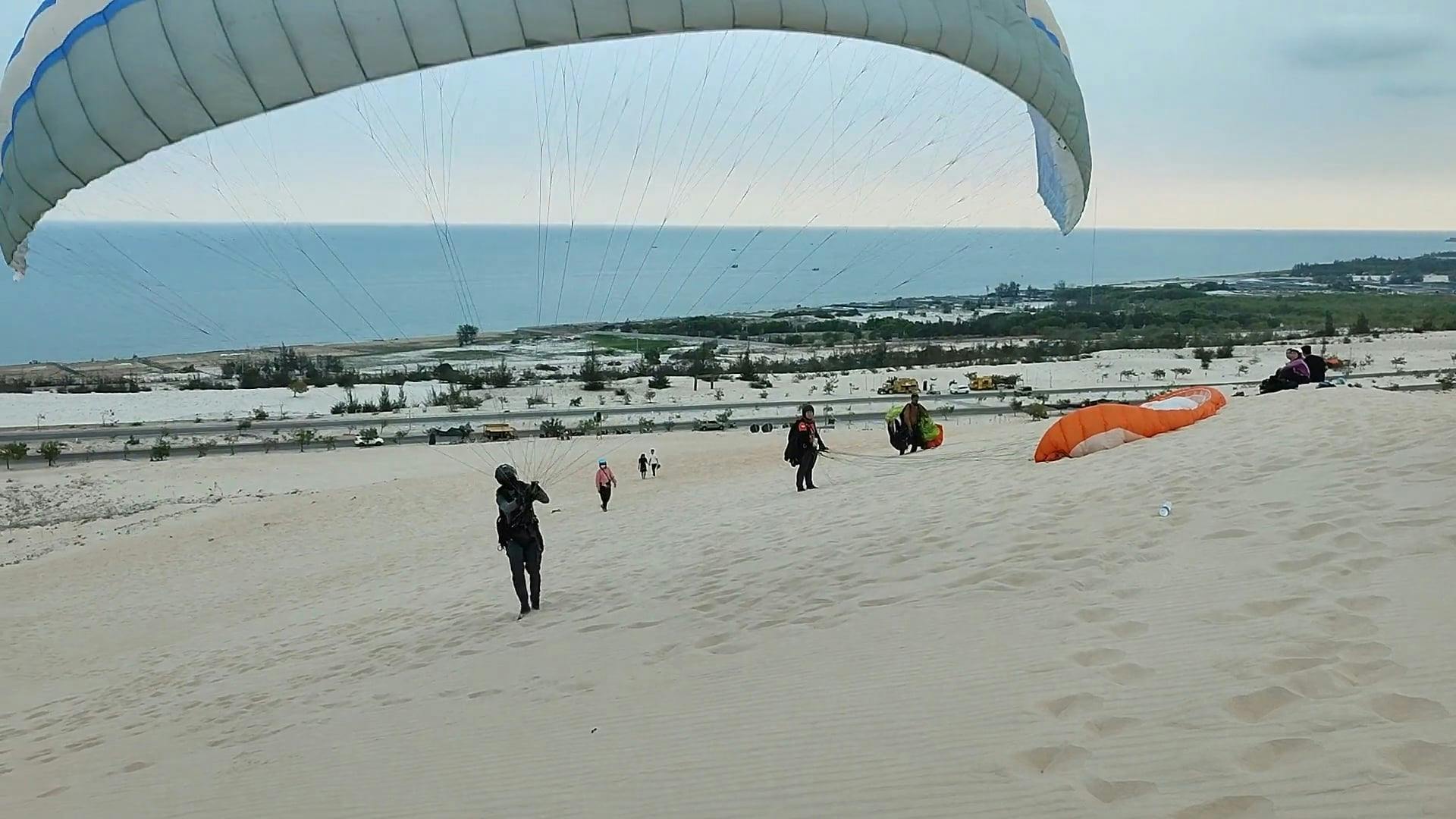 A Couple Paragliding Over The Blue Water Of The Sea Free Stock Video ...