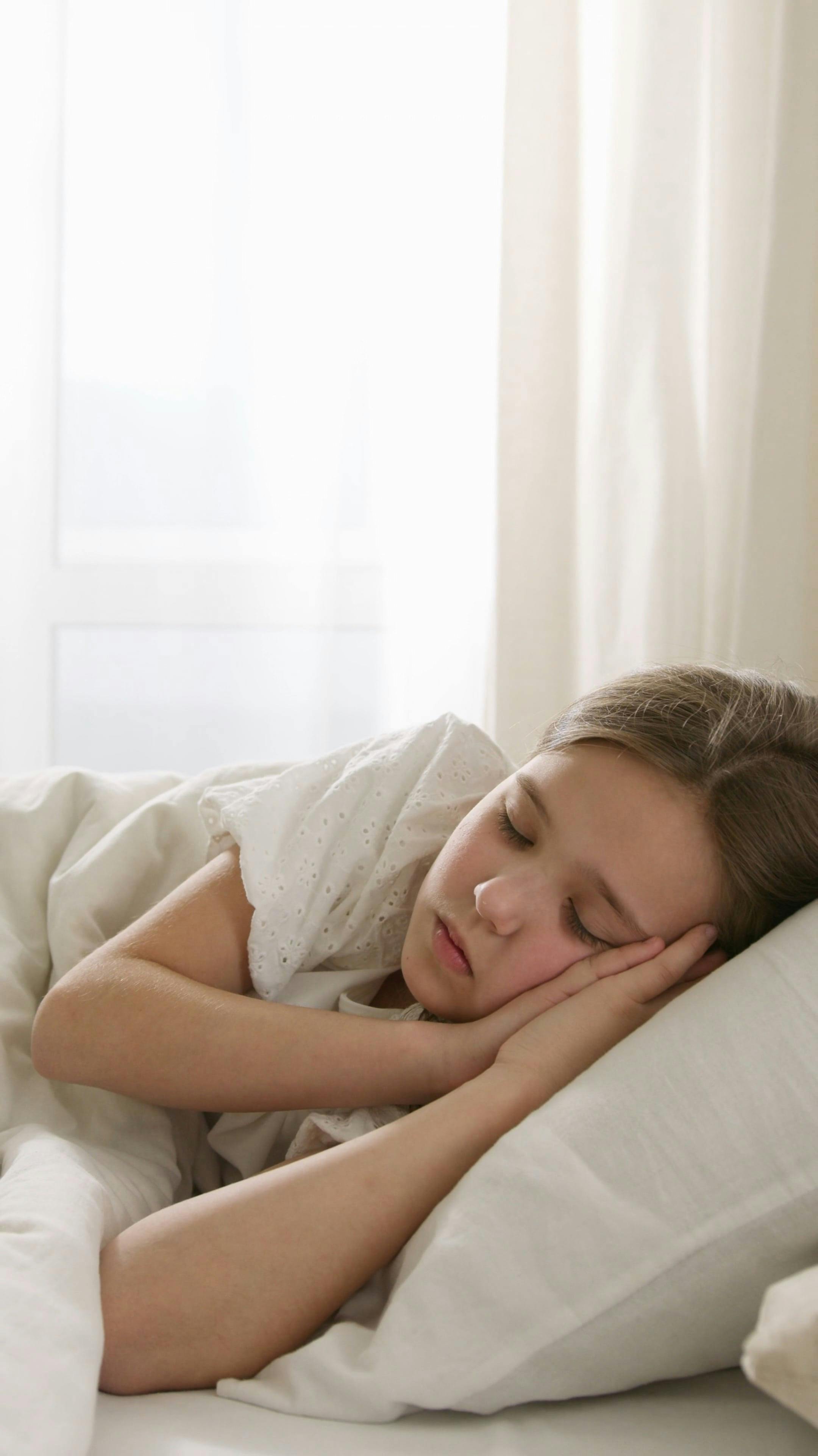 A Young Girl Getting Up from Bed while Looking at the Sea View Free ...